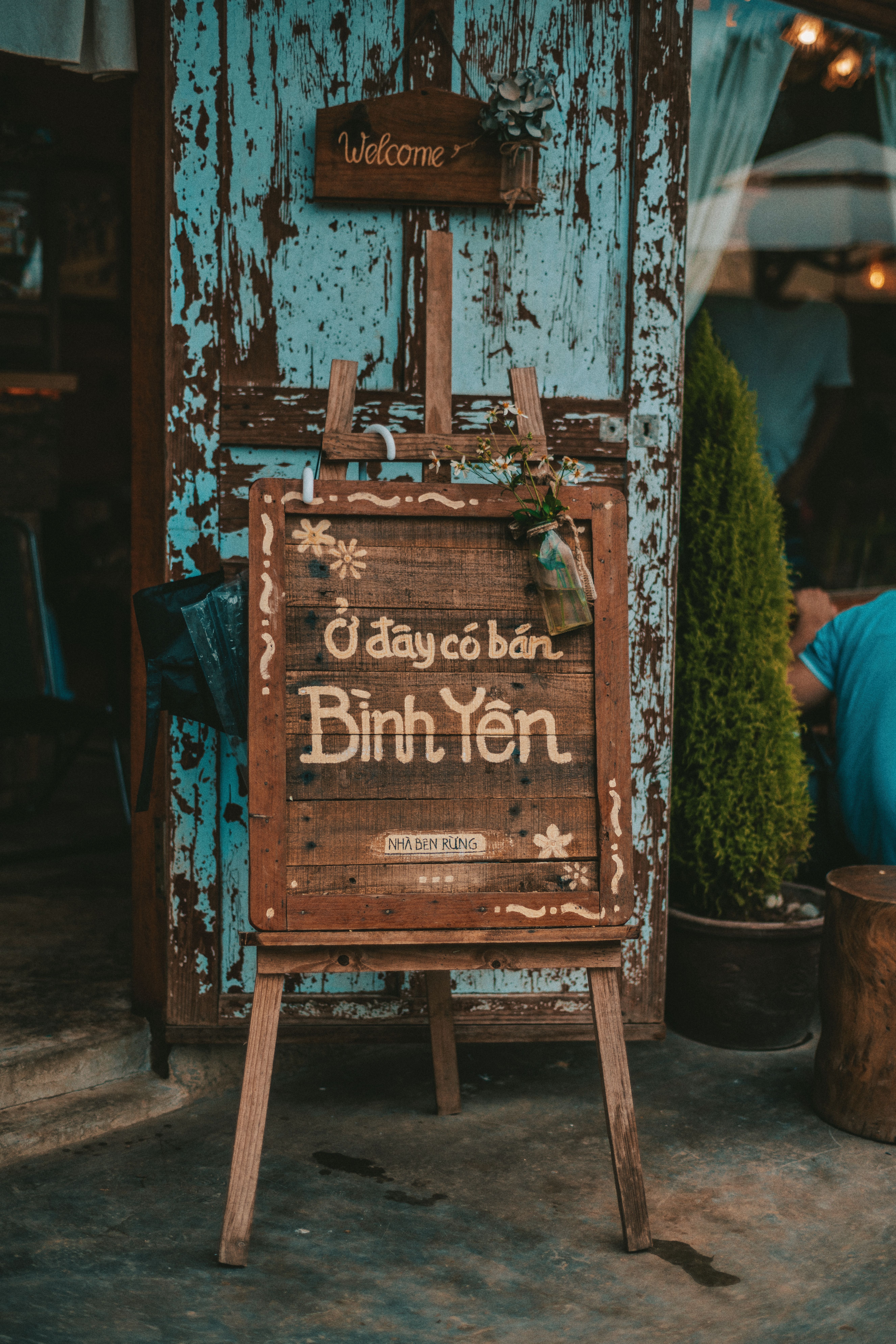 Rustic Cafe Entrance with Welcome Sign · Free Stock Photo