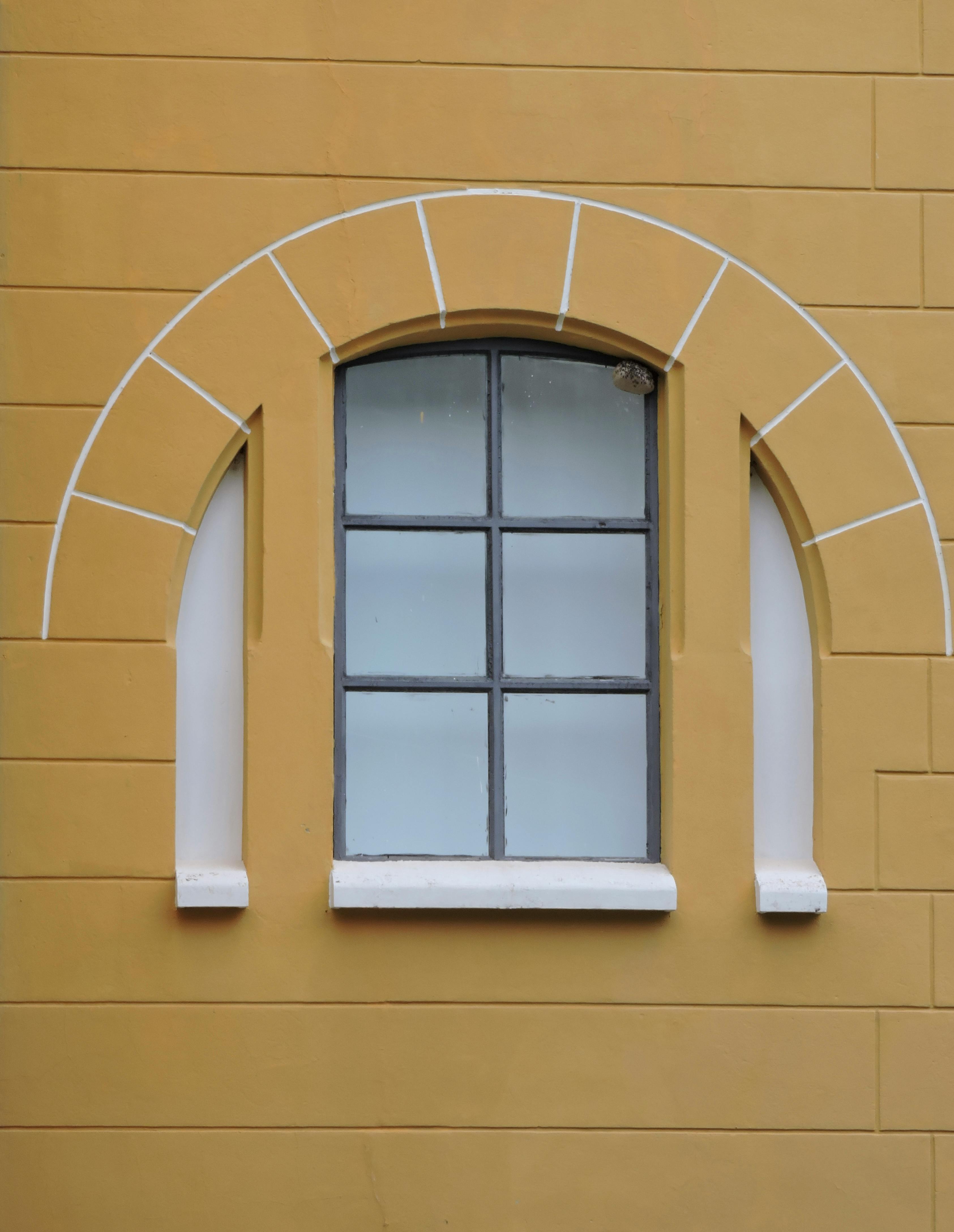 Architectural Detail of Arched Window on Yellow Wall · Free Stock Photo