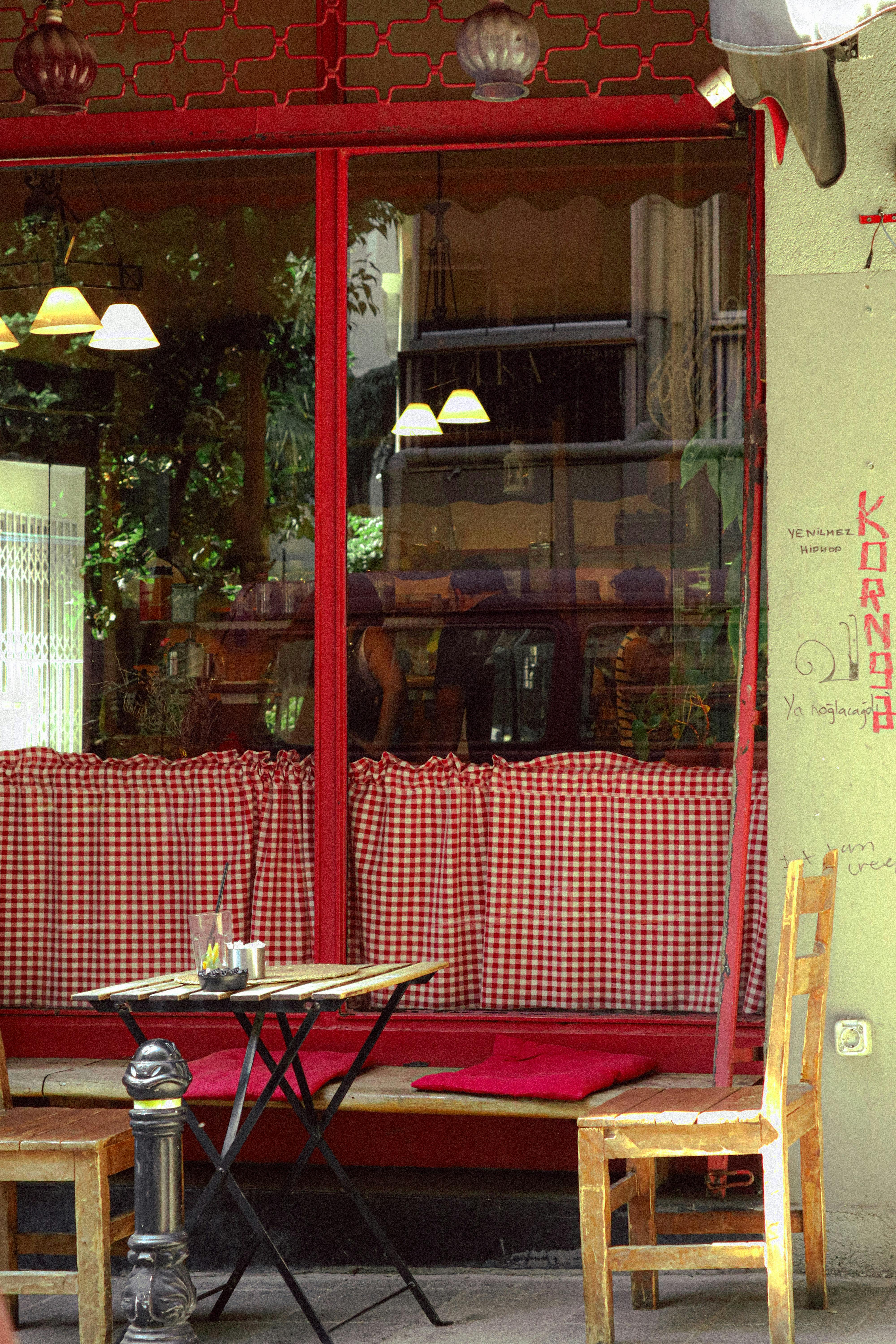 Charming Cafe Exterior with Red Checkered Curtains · Free Stock Photo