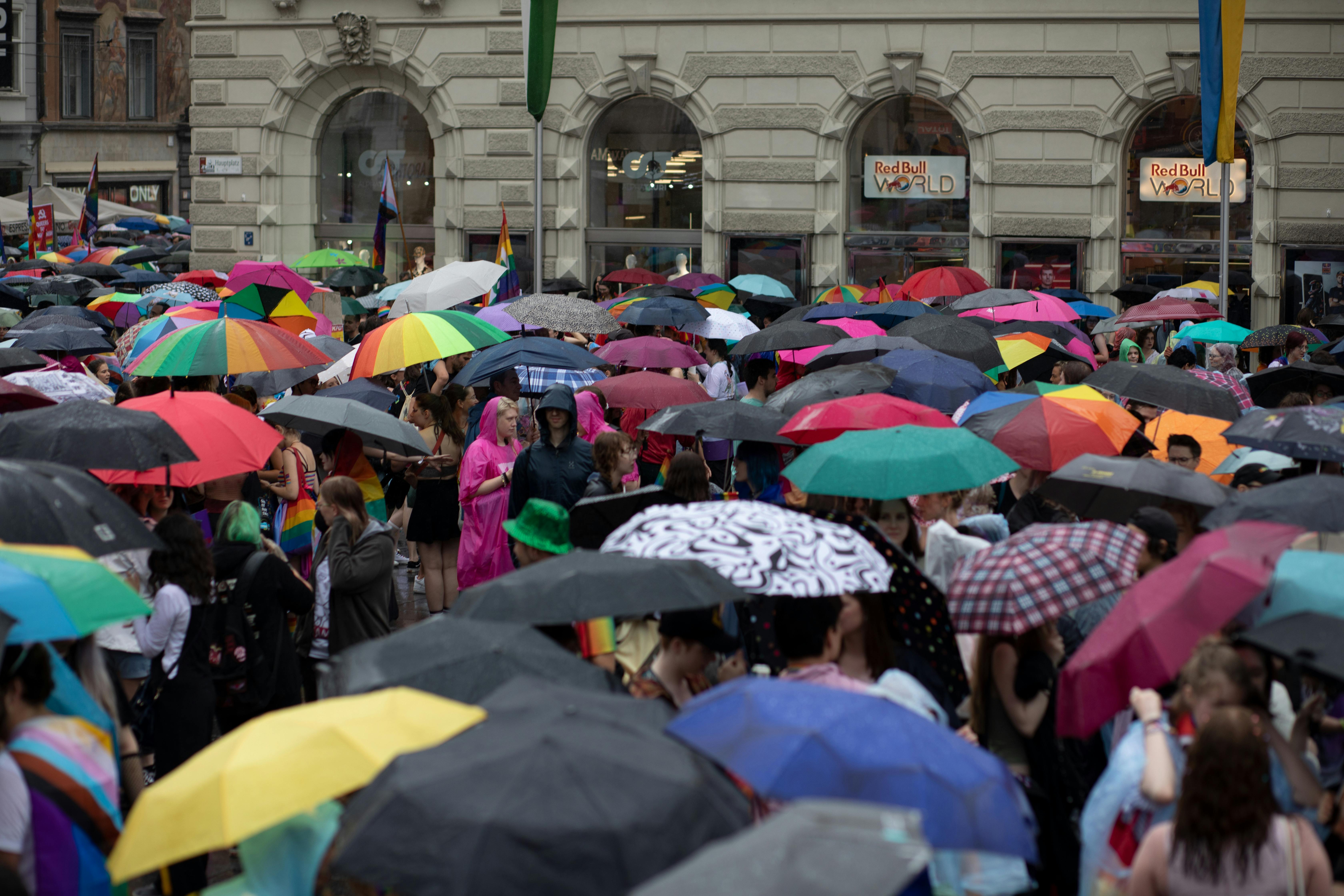 Colorful Umbrellas at a Rainy Pride Parade · Free Stock Photo