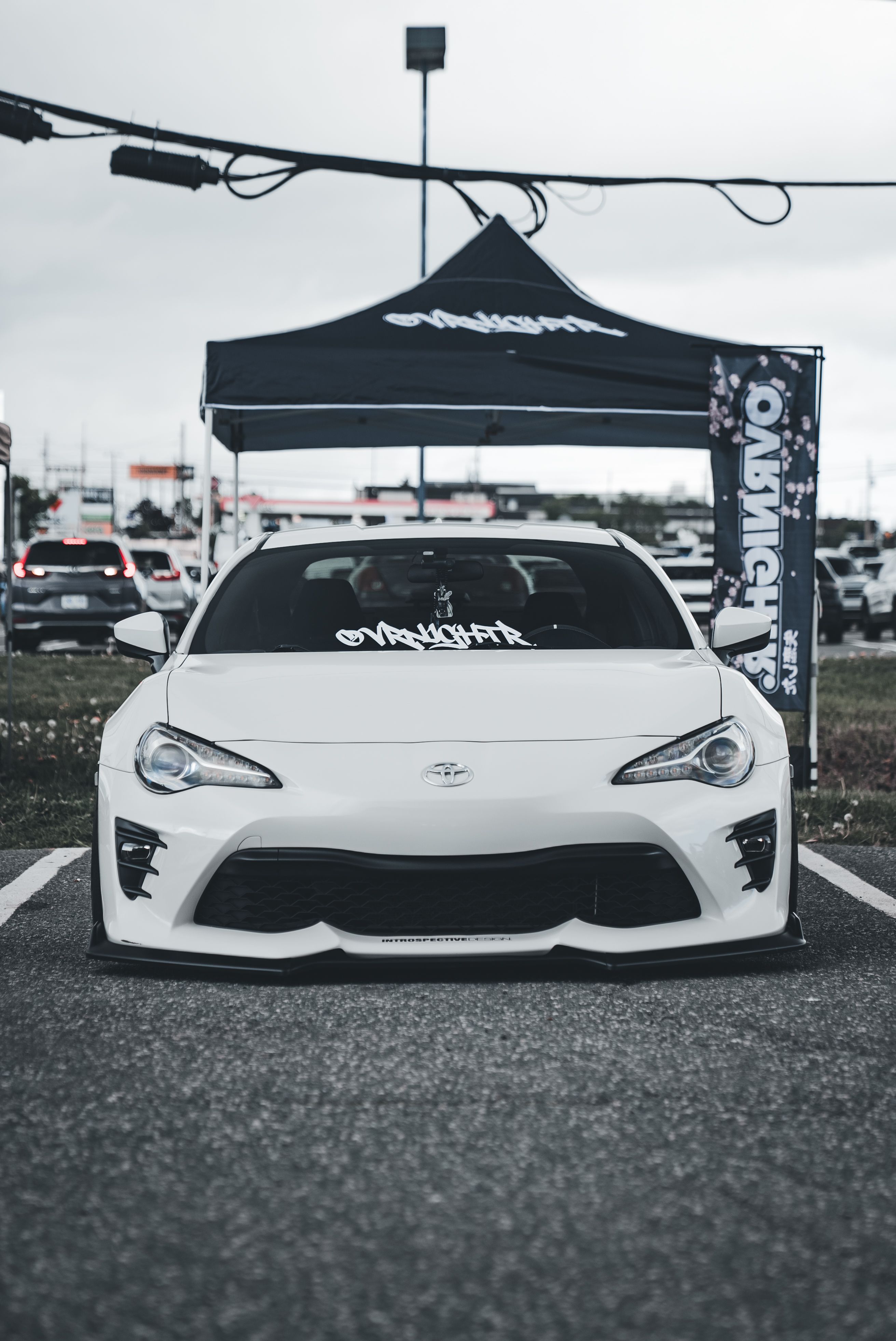 Front View of Sleek White Car at Outdoor Auto Show · Free Stock Photo