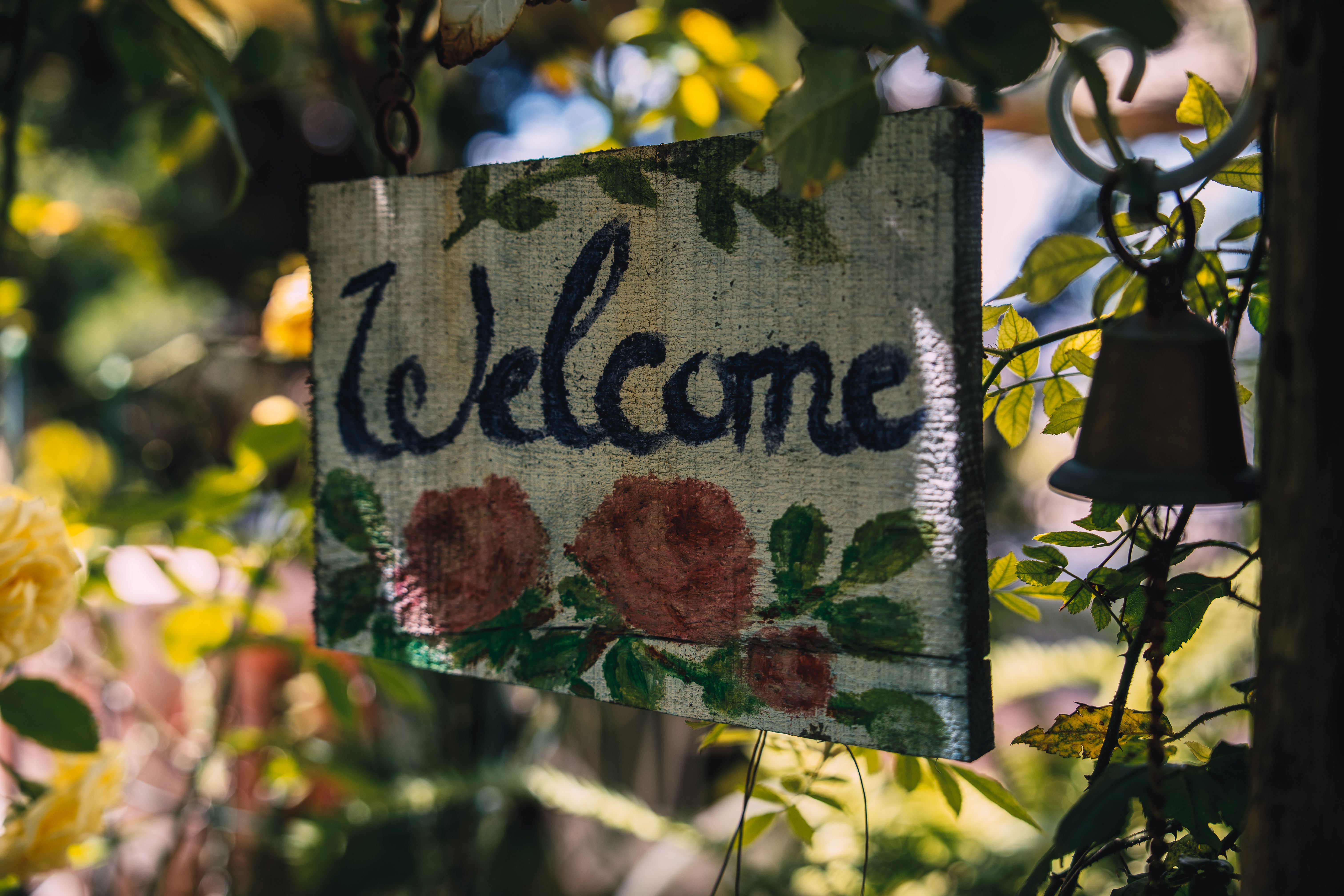 Charming Garden Welcome Sign with Roses · Free Stock Photo