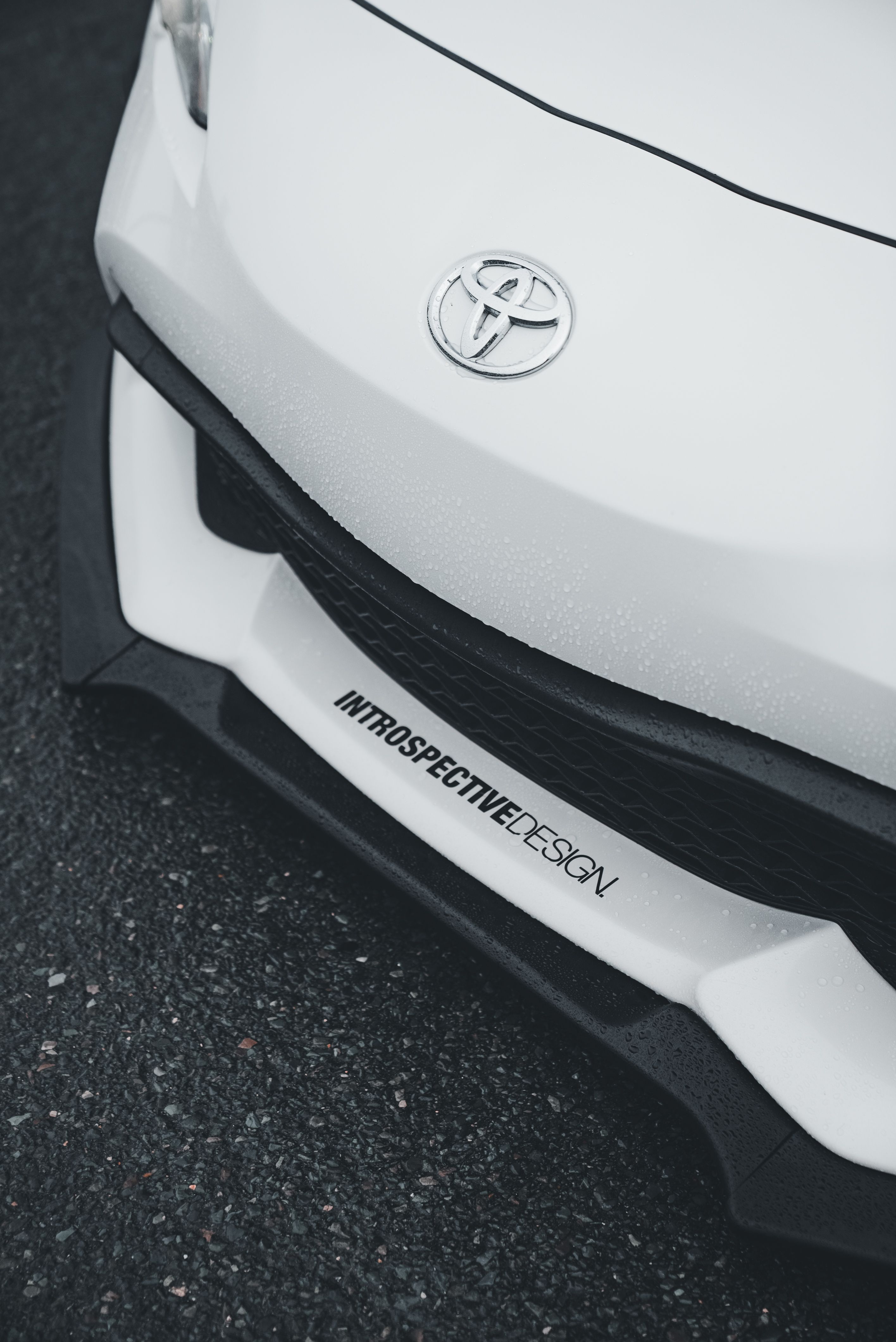 Close-Up of White Sports Car Front Bumper · Free Stock Photo
