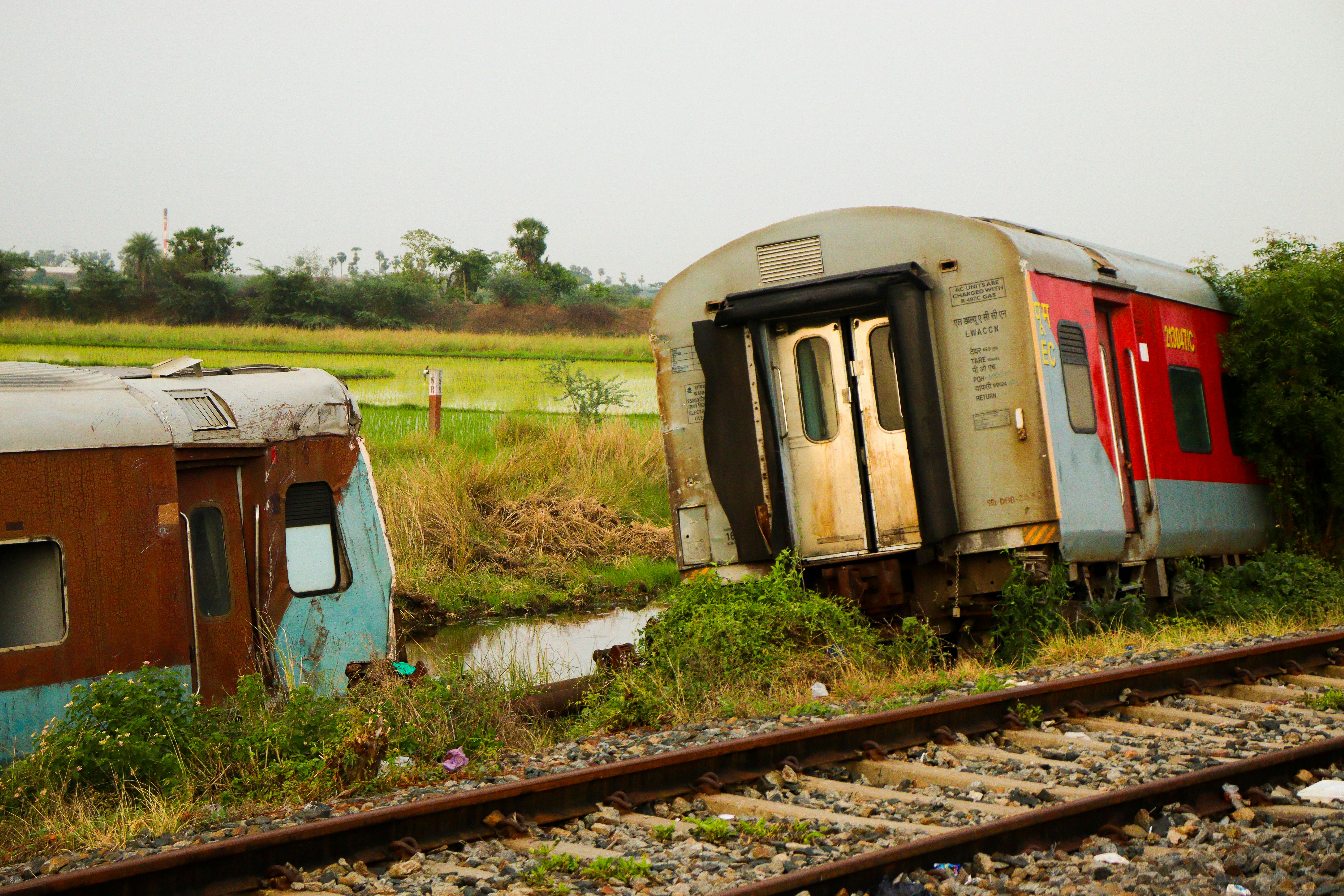 Abandoned Train Cars in a Rural Landscape · Free Stock Photo