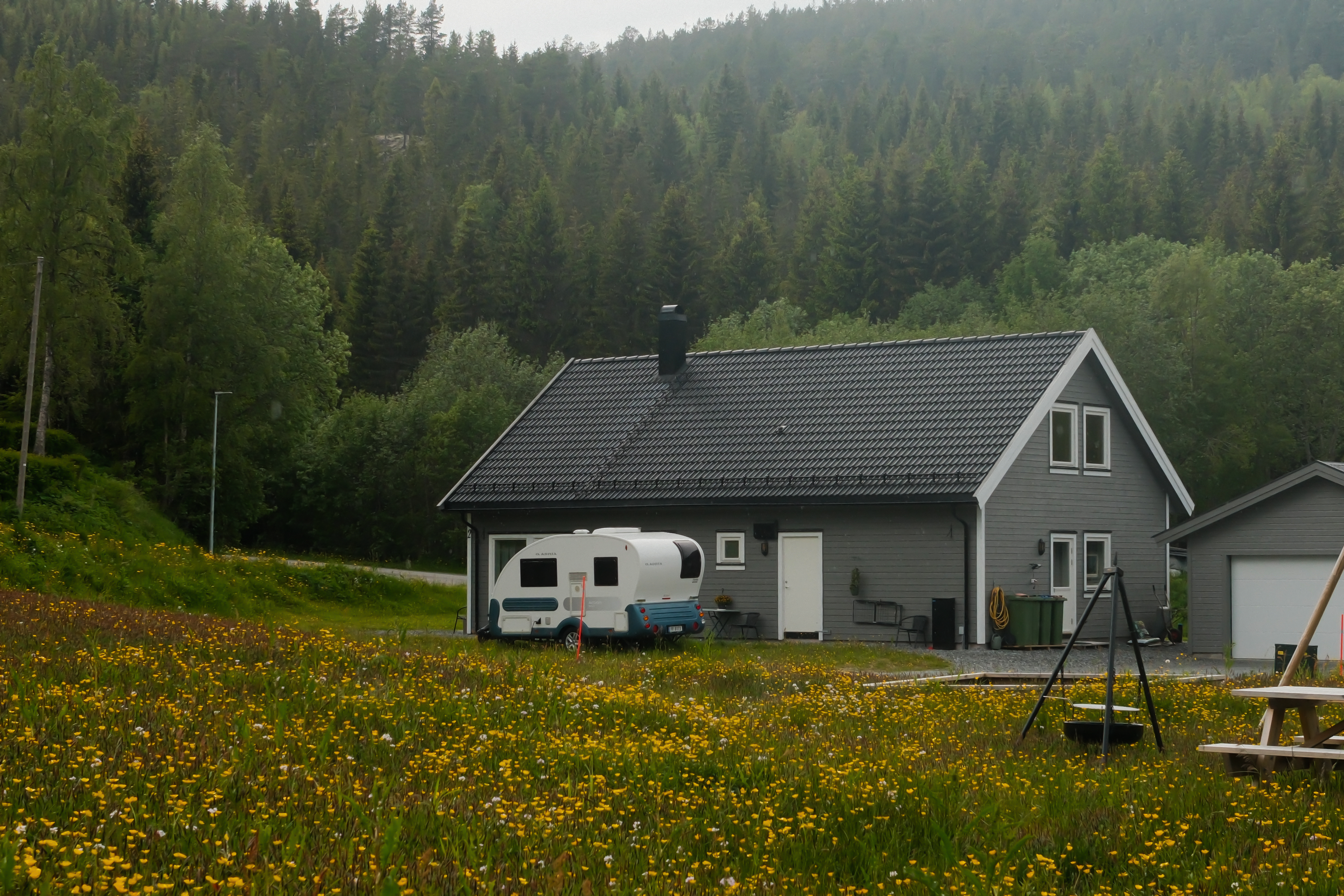 Scenic Mountain Cabin with Caravan in Blooming Meadow · Free Stock Photo