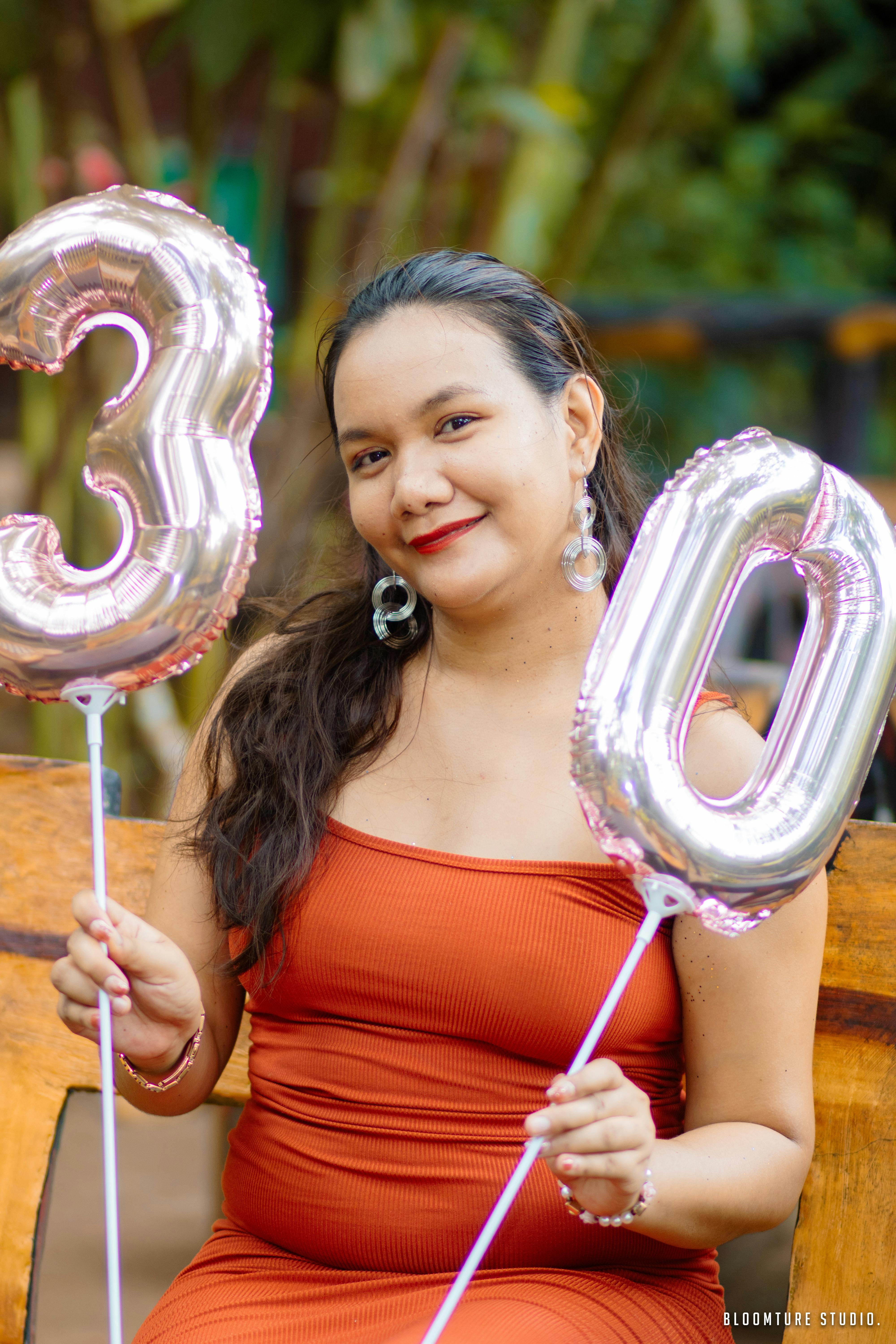Woman Celebrating 30th Birthday Outdoors with Balloons · Free Stock Photo