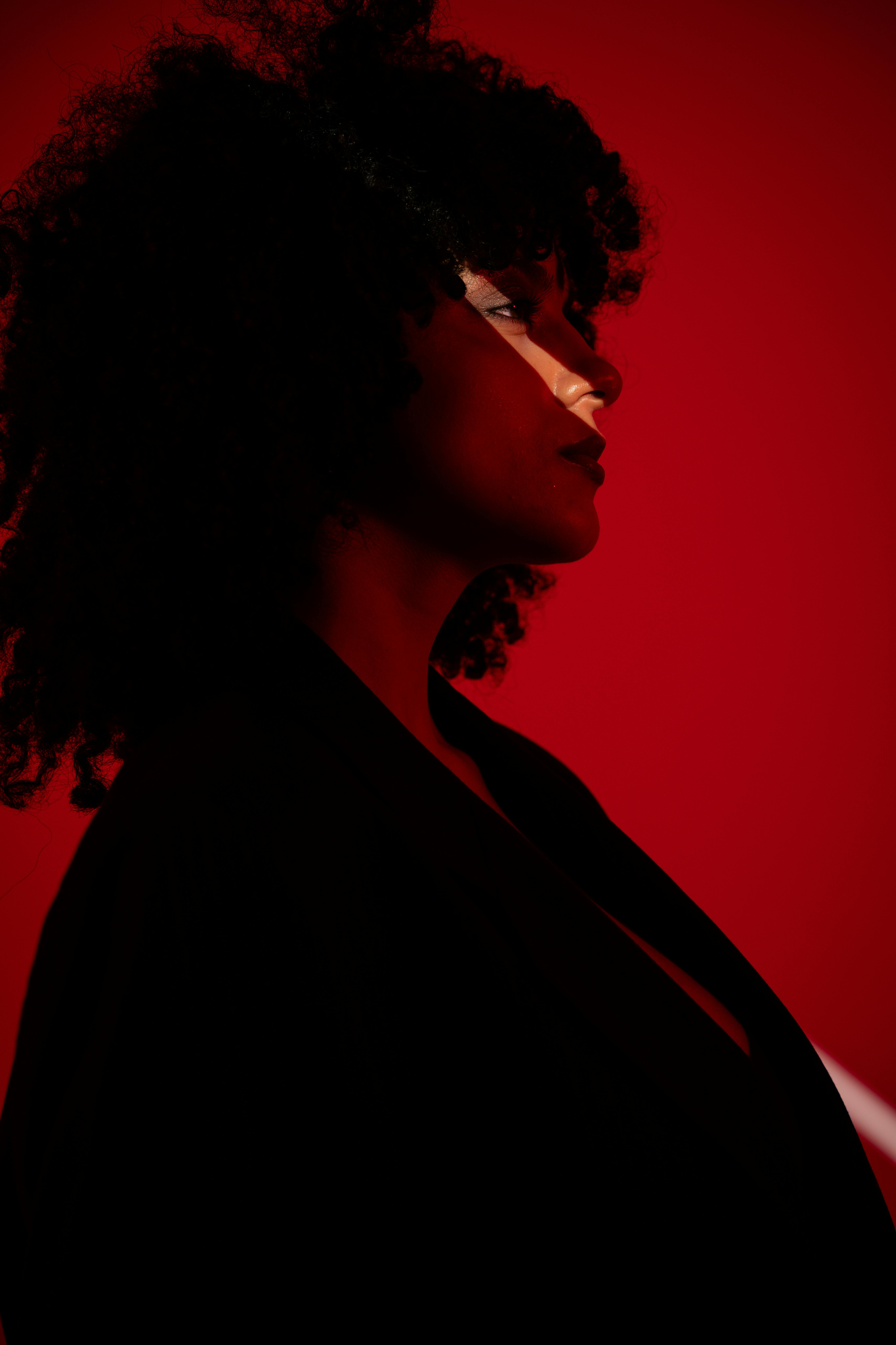Artistic Cinematic Portrait with Red Backdrop · Free Stock Photo