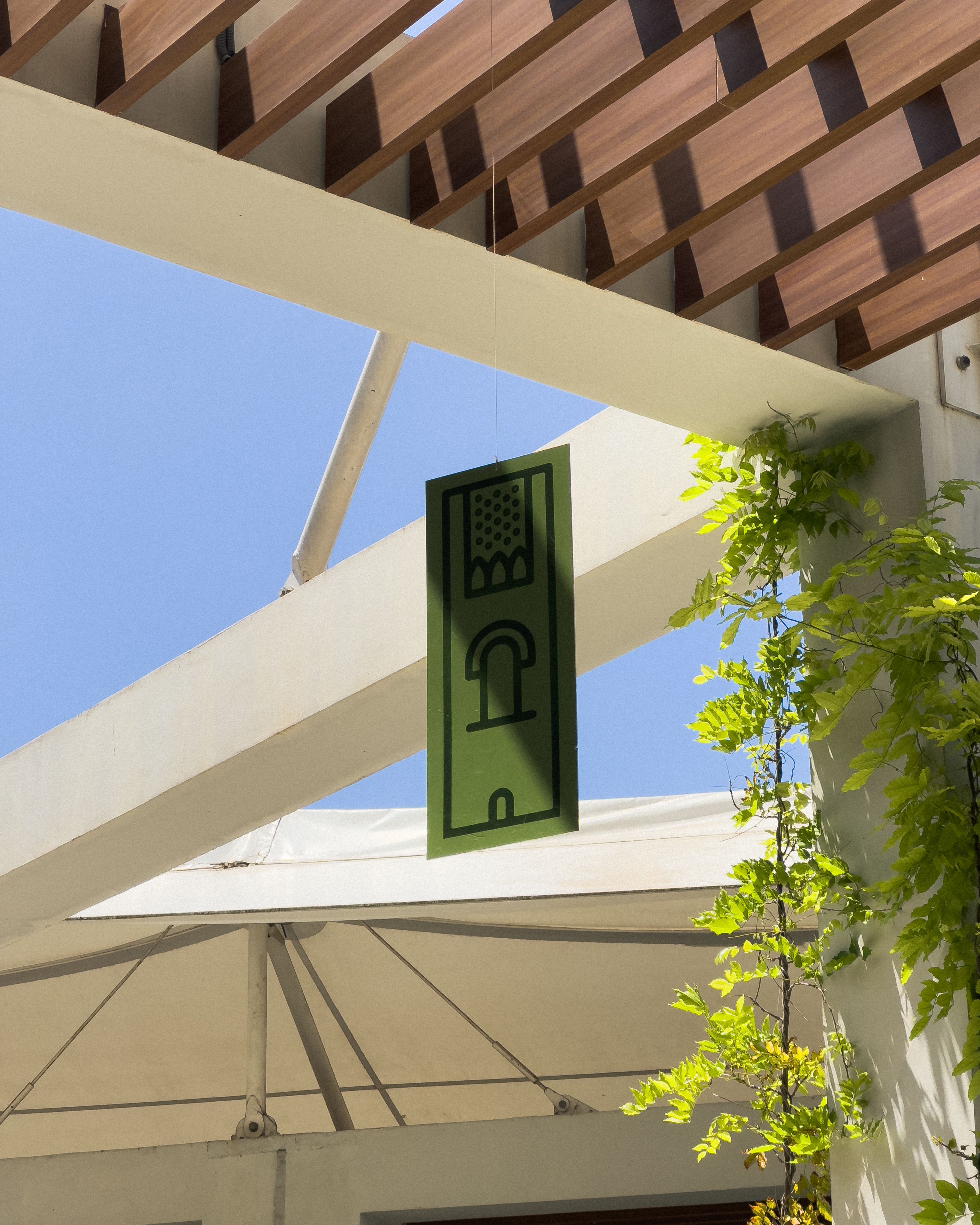 Modern Green Sign in Outdoor Geometric Structure · Free Stock Photo