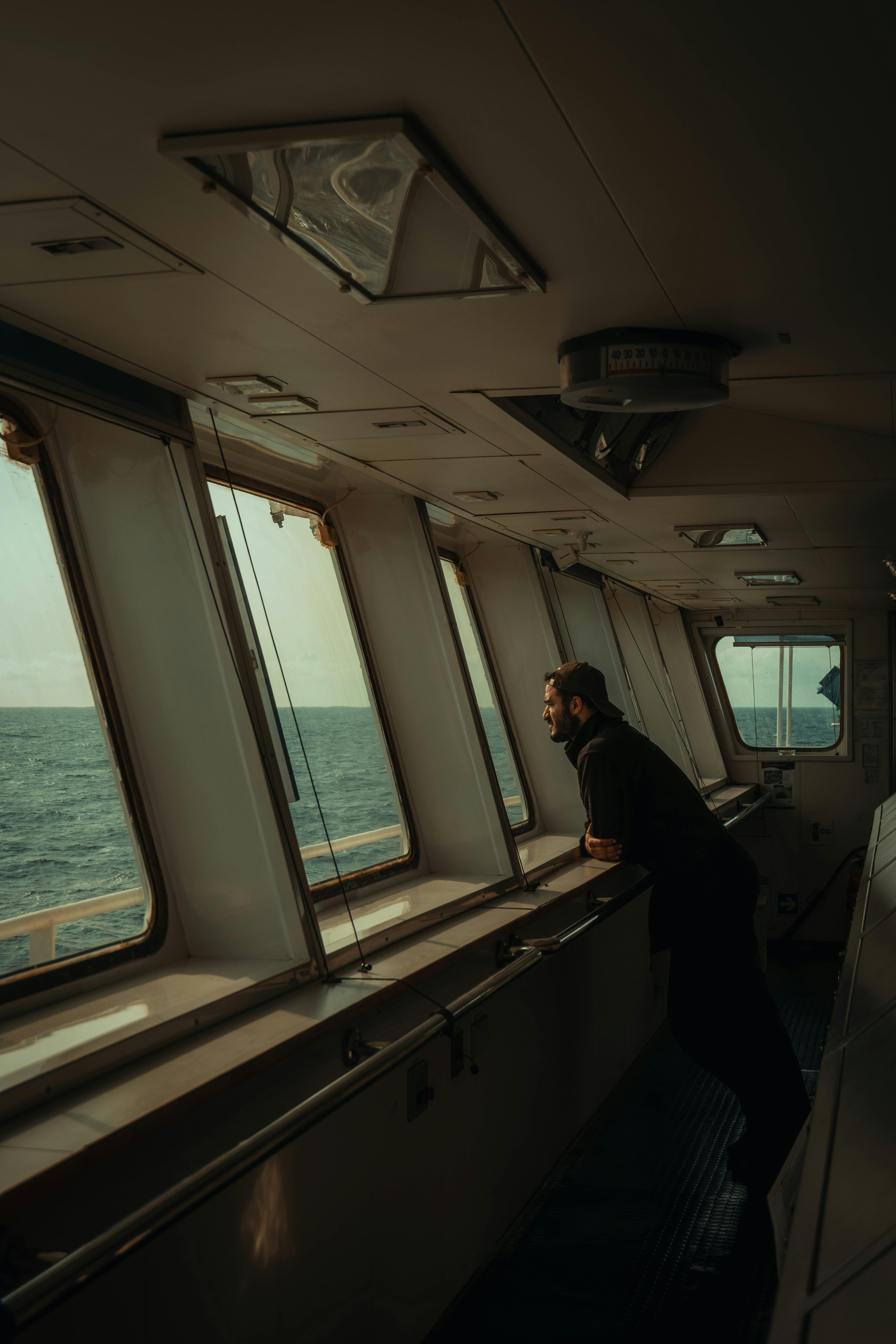 Man Contemplating the Ocean from a Ship's Deck · Free Stock Photo