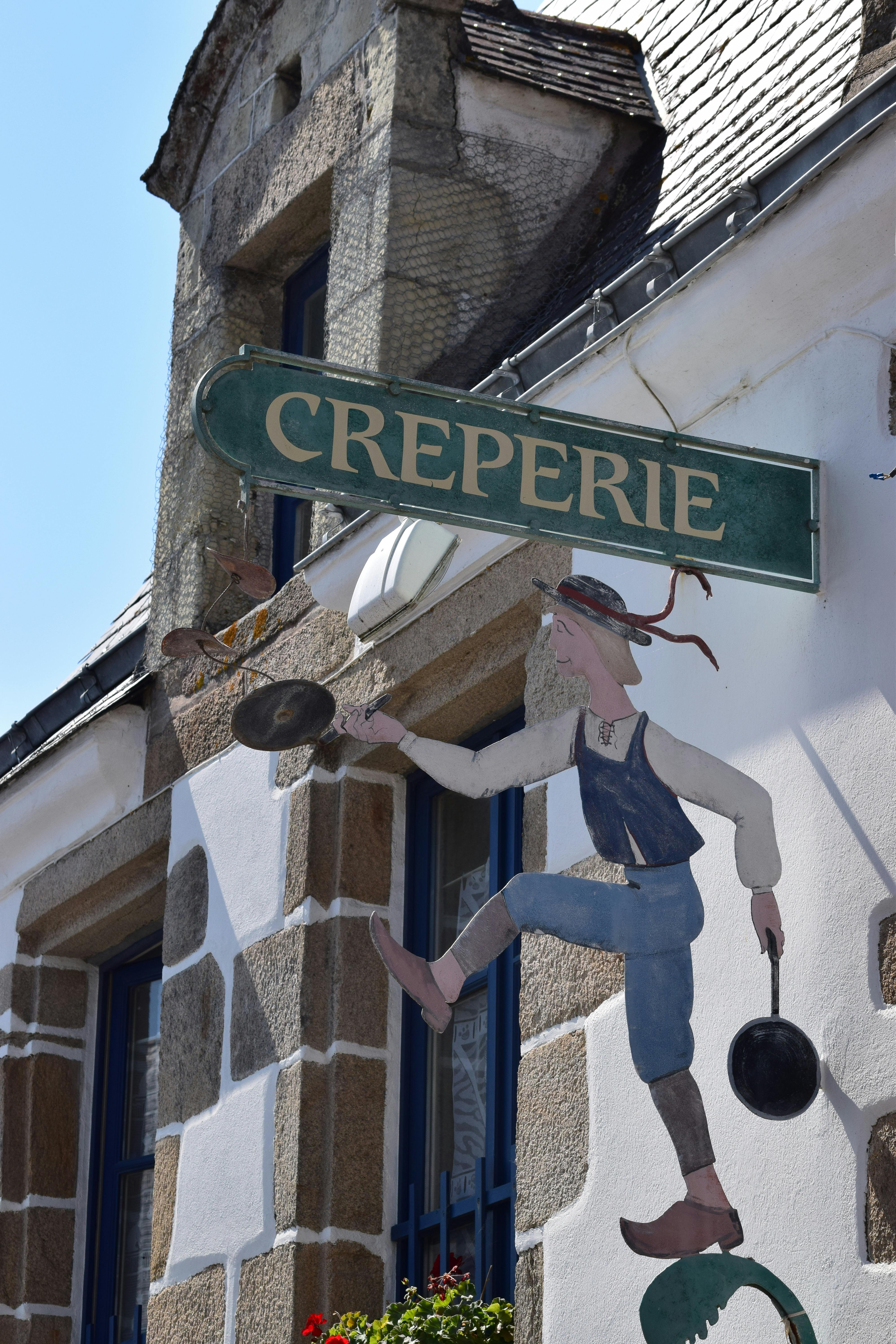 Charming Creperie Sign in Sunny French Town · Free Stock Photo