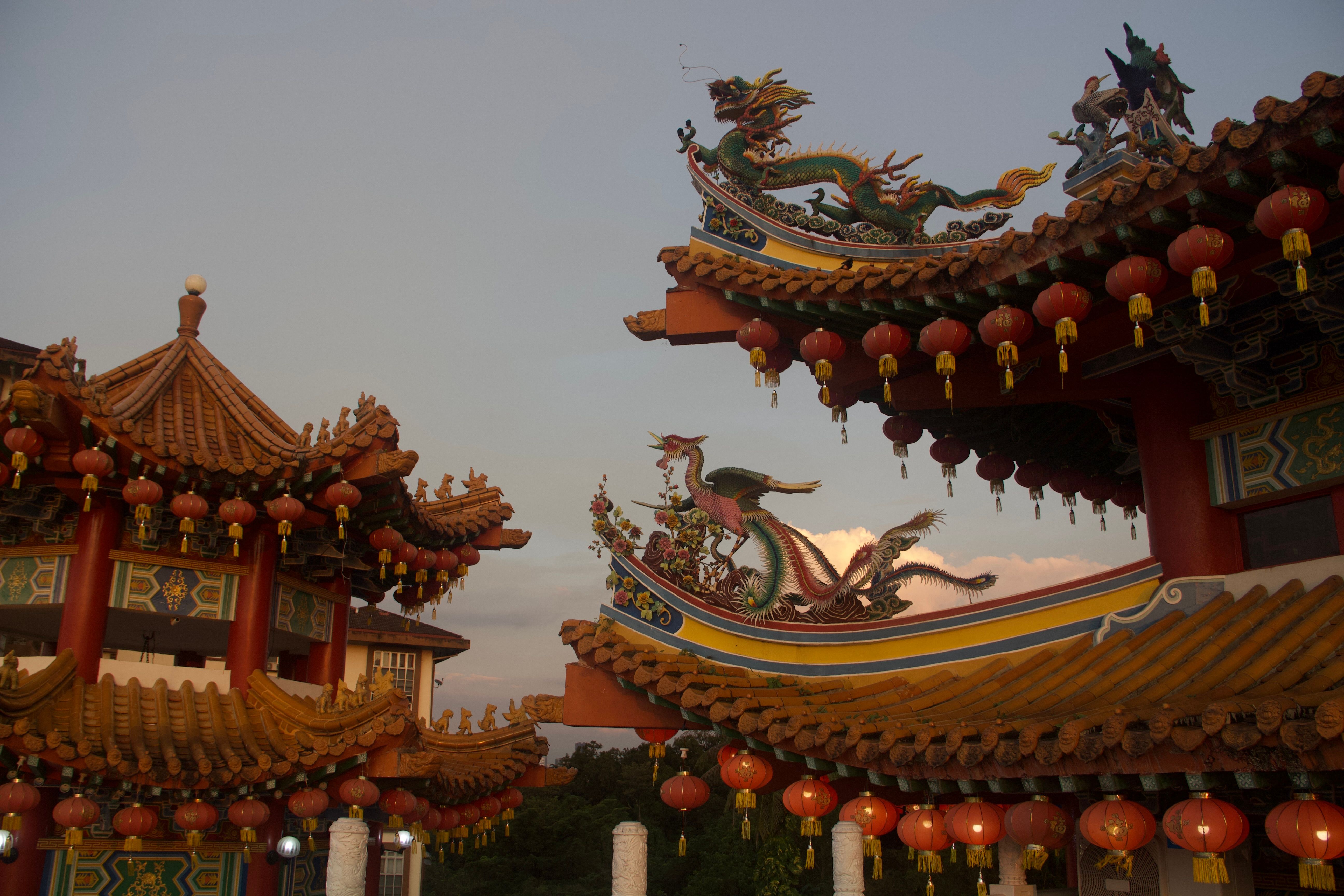 Traditional Chinese Temple Rooftop Decorations at Sunset · Free Stock Photo