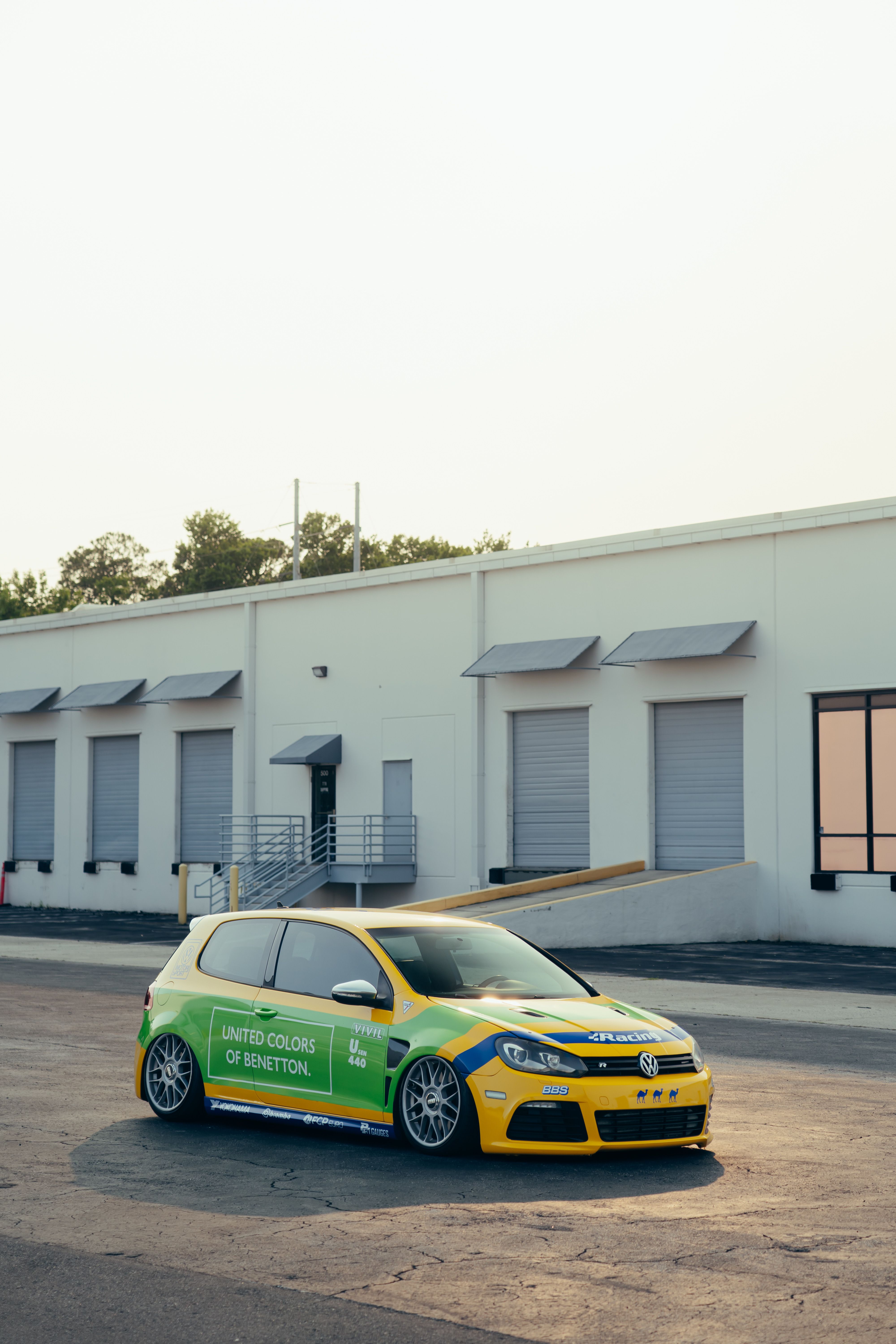Vibrant Car in Industrial Setting at Daytime · Free Stock Photo