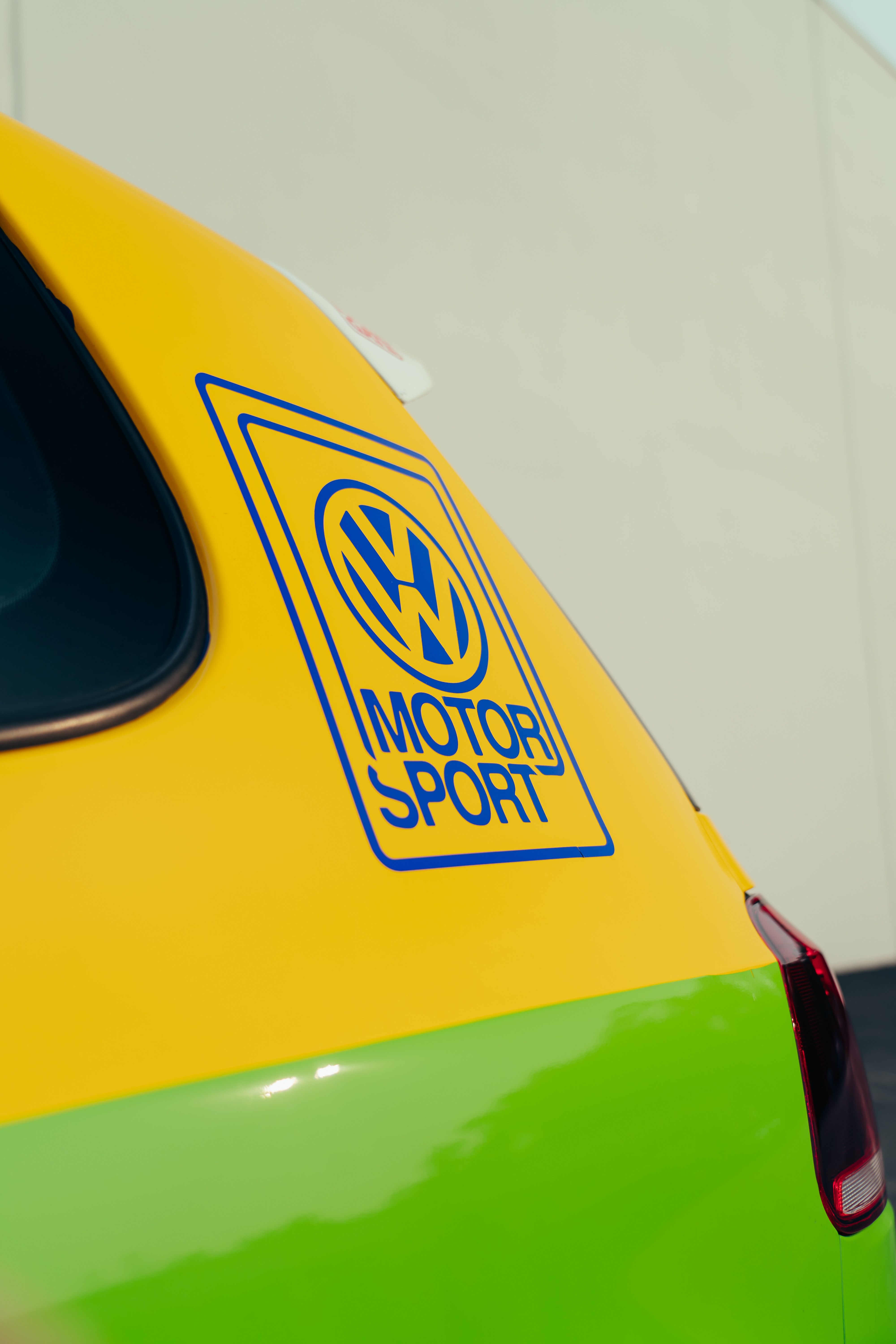 Close-up of Brightly Colored Car with Motorsport Logo · Free Stock Photo