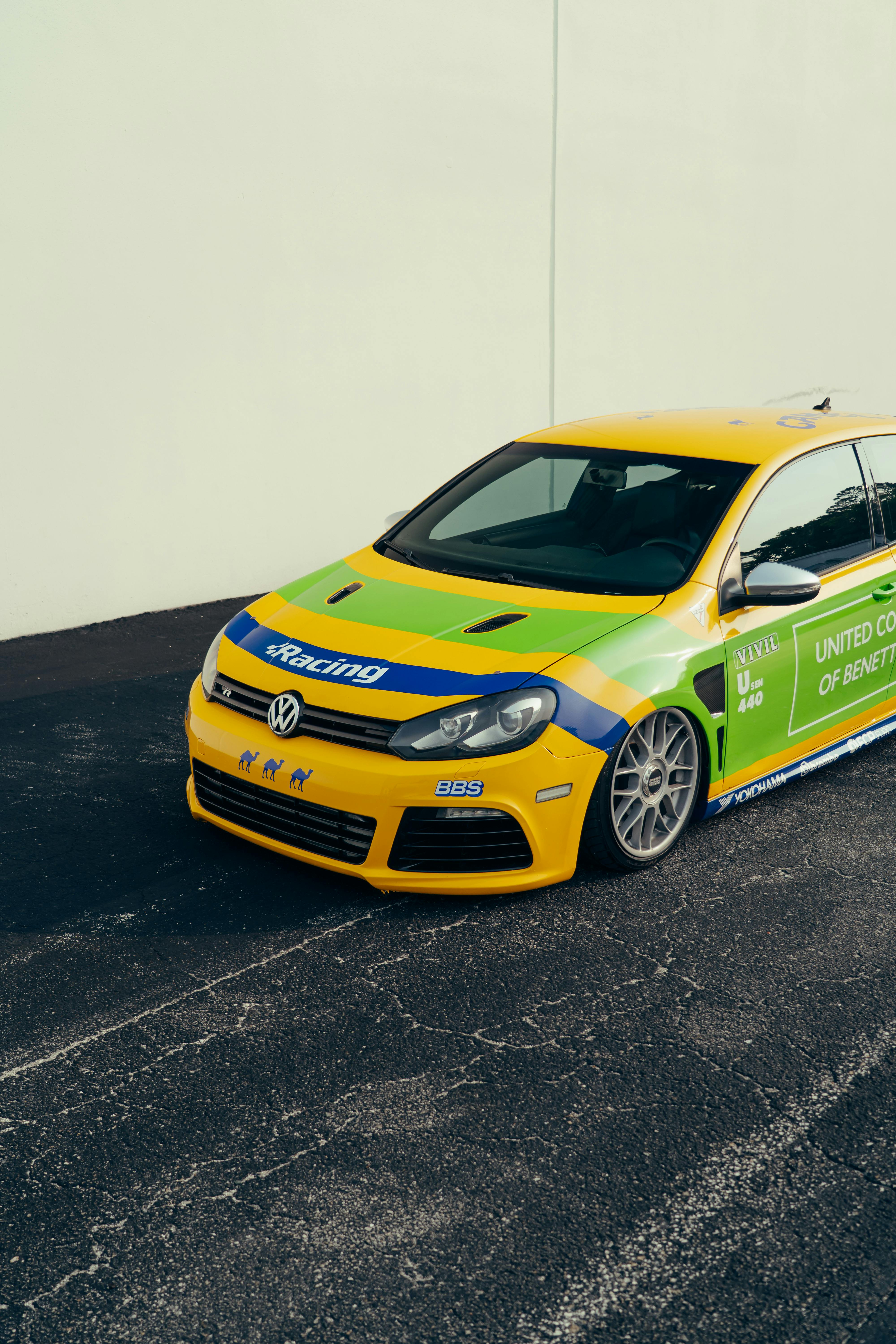 Colorful Racing Car Displayed on Asphalt · Free Stock Photo