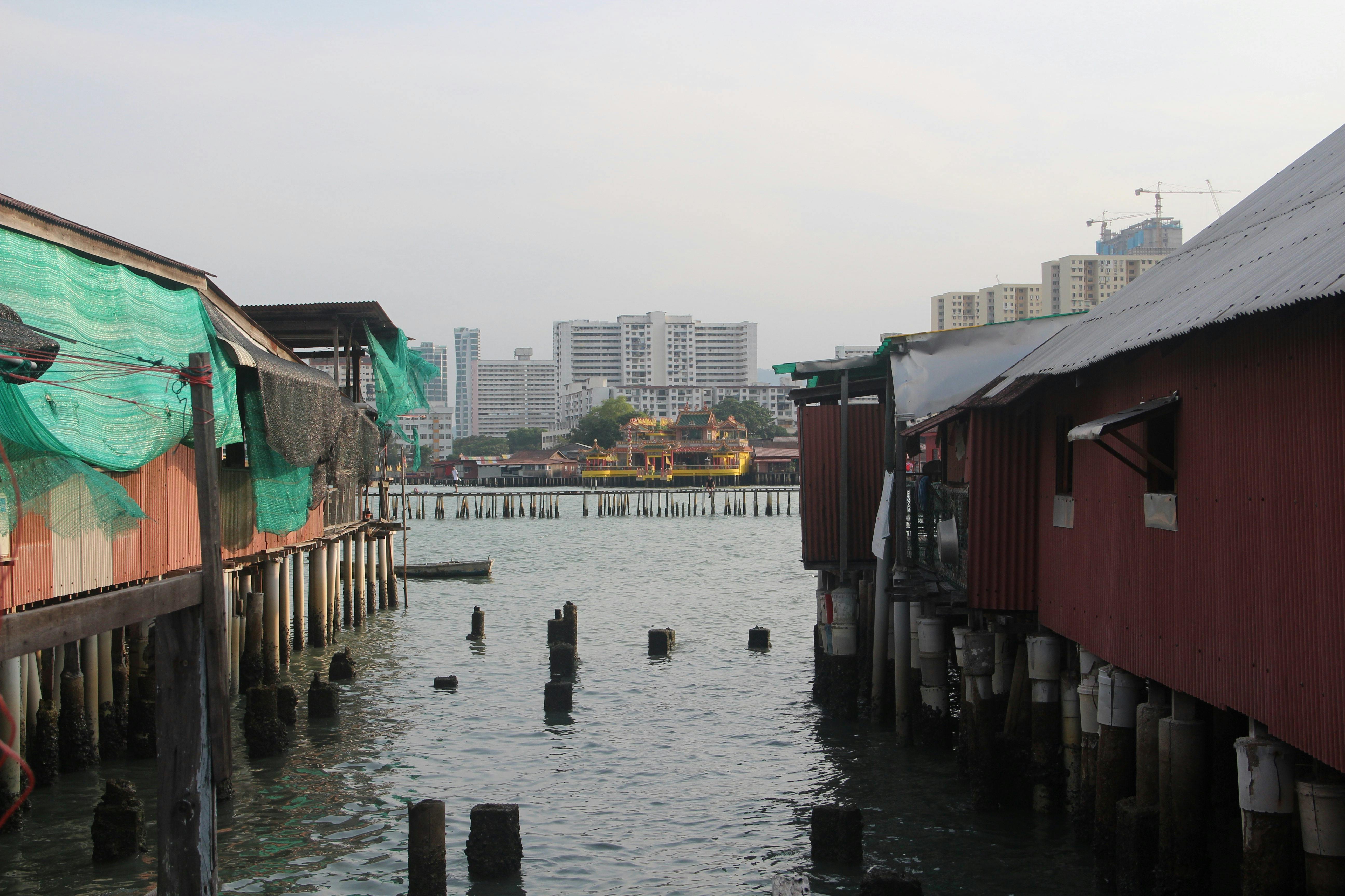 Stilt Houses Over Water in Coastal Cityscape · Free Stock Photo