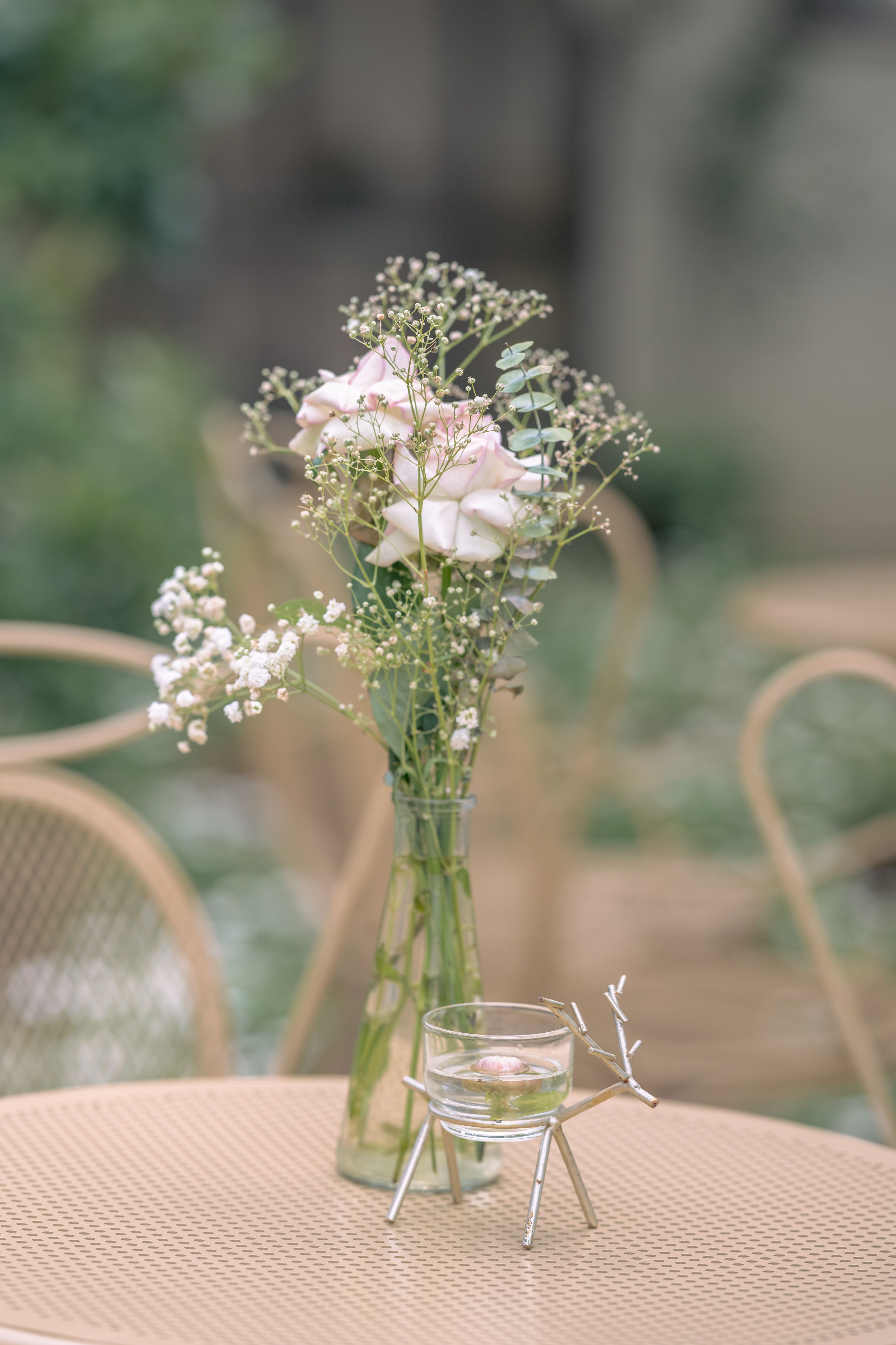Elegant Floral Arrangement on Outdoor Cafe Table · Free Stock Photo