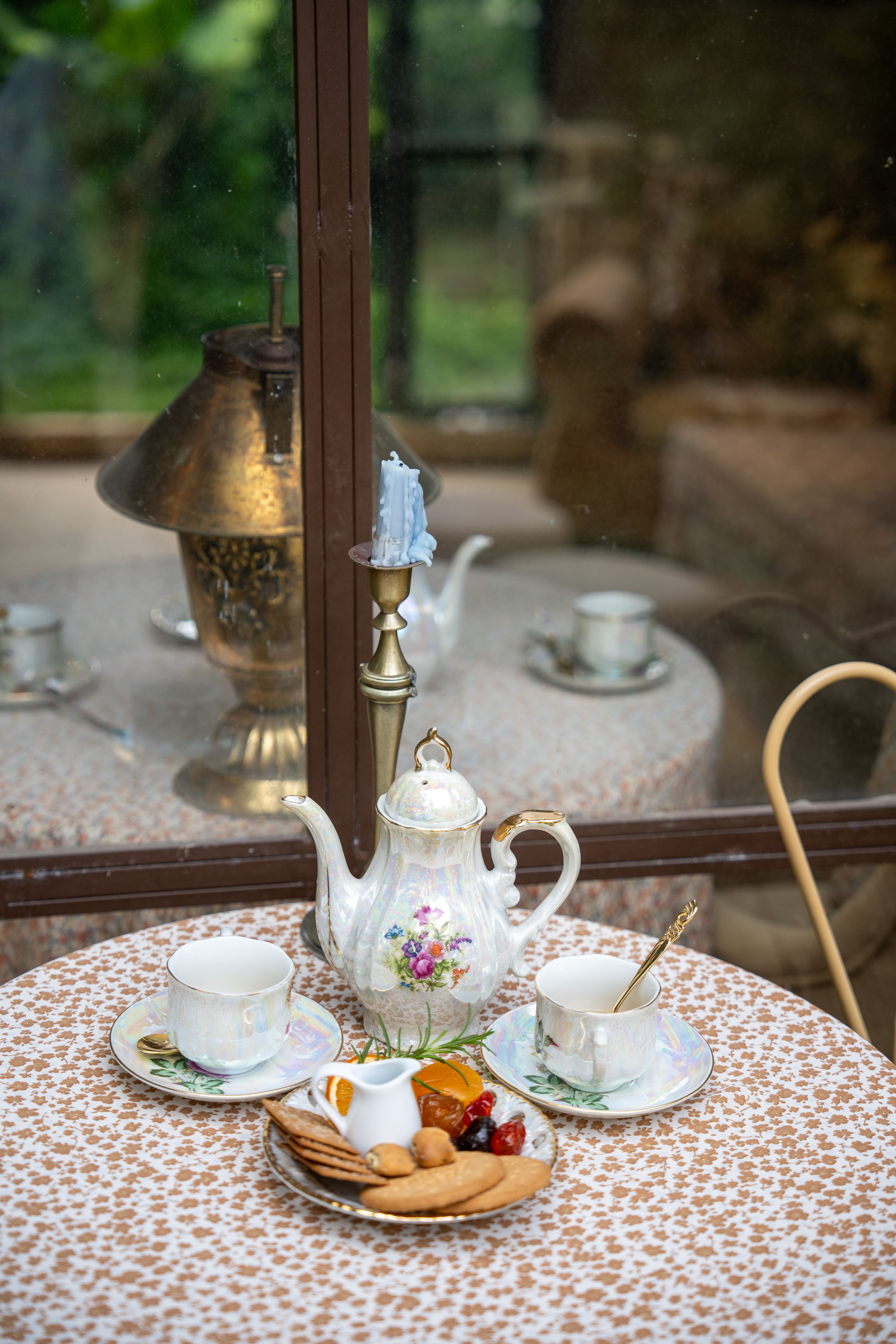 Elegant Tea Set with Snacks on Floral Table · Free Stock Photo