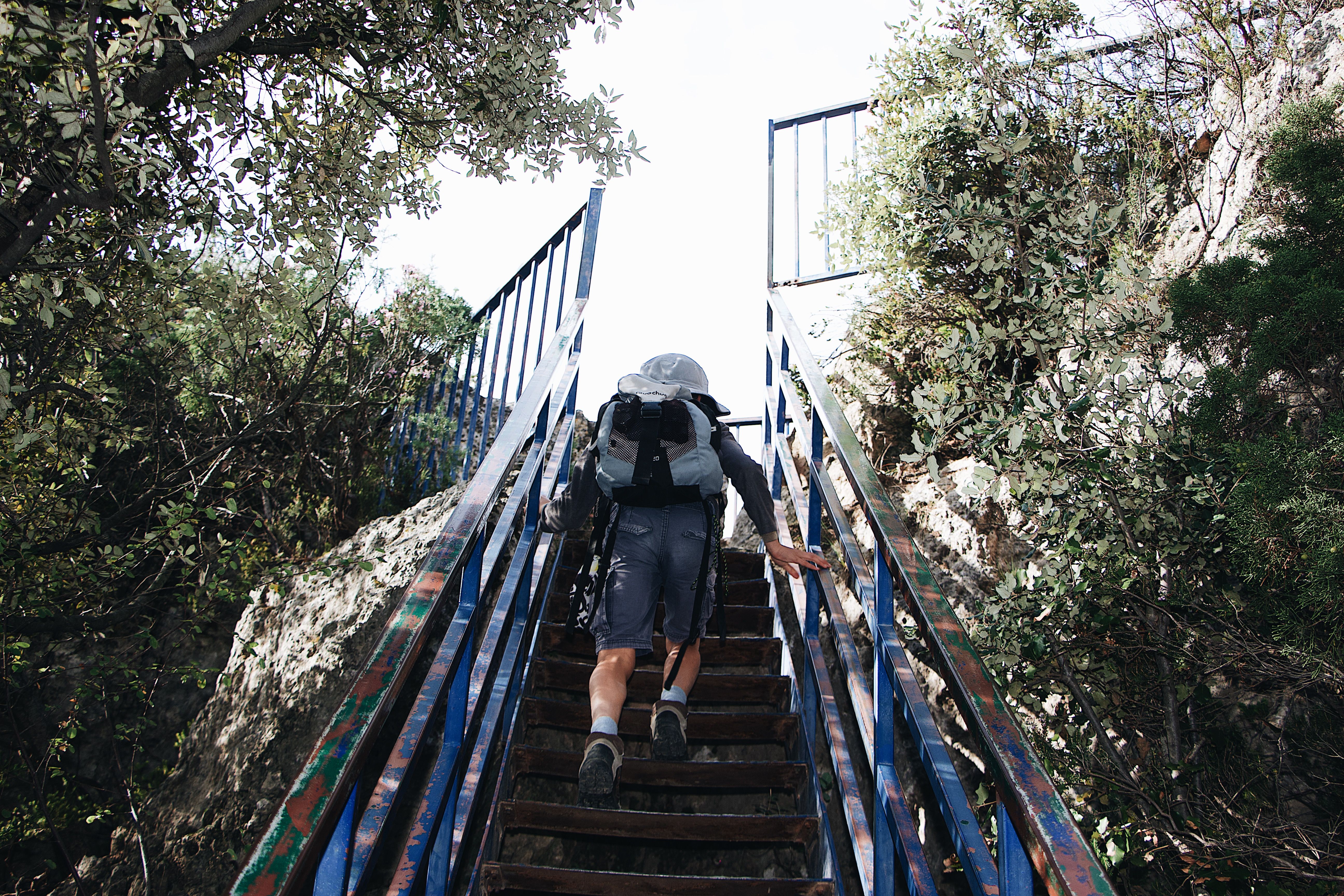 Man Wearing Backpack Going Upstairs · Free Stock Photo