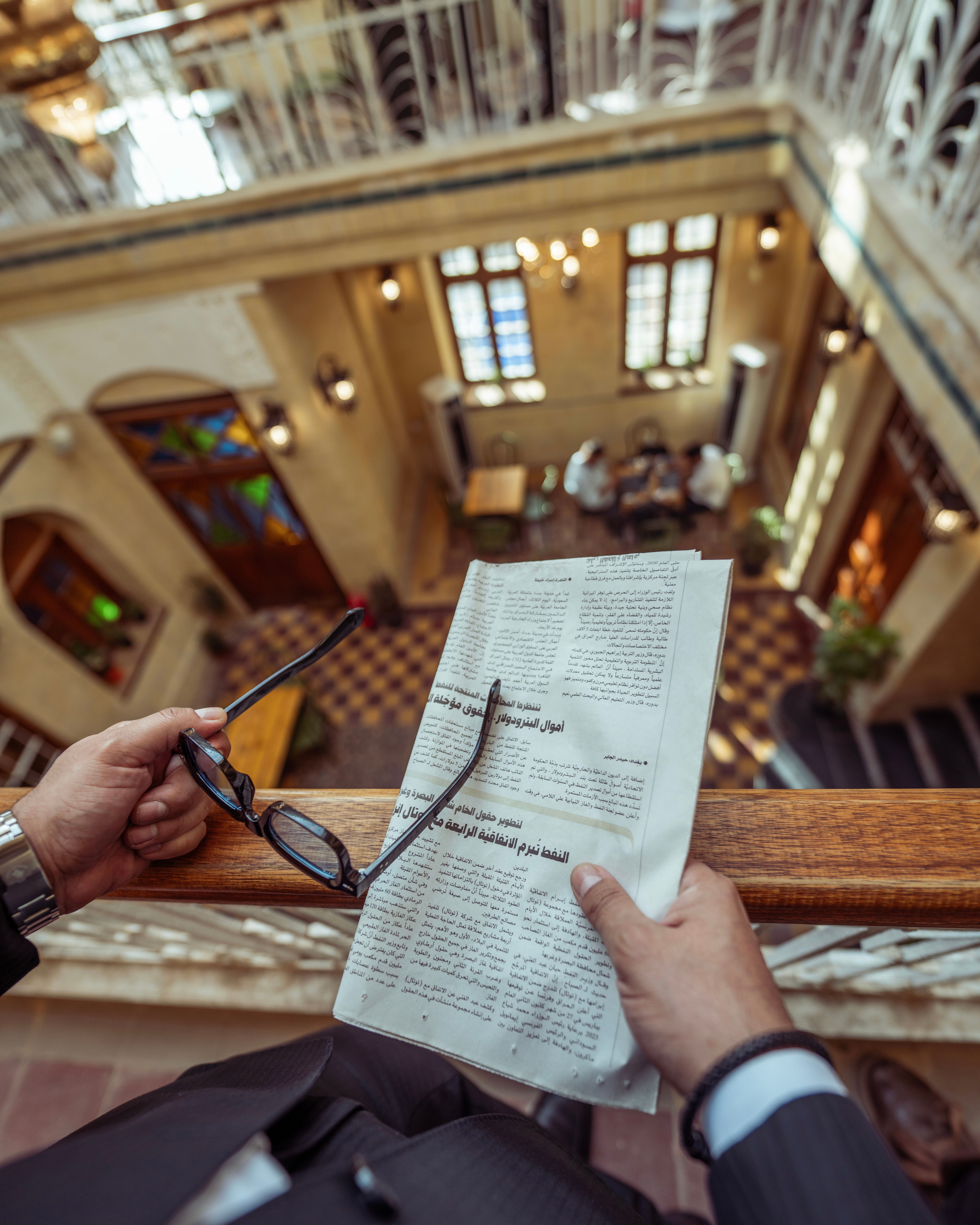 Businessman reading newspaper in historic Baghdad building · Free Stock ...