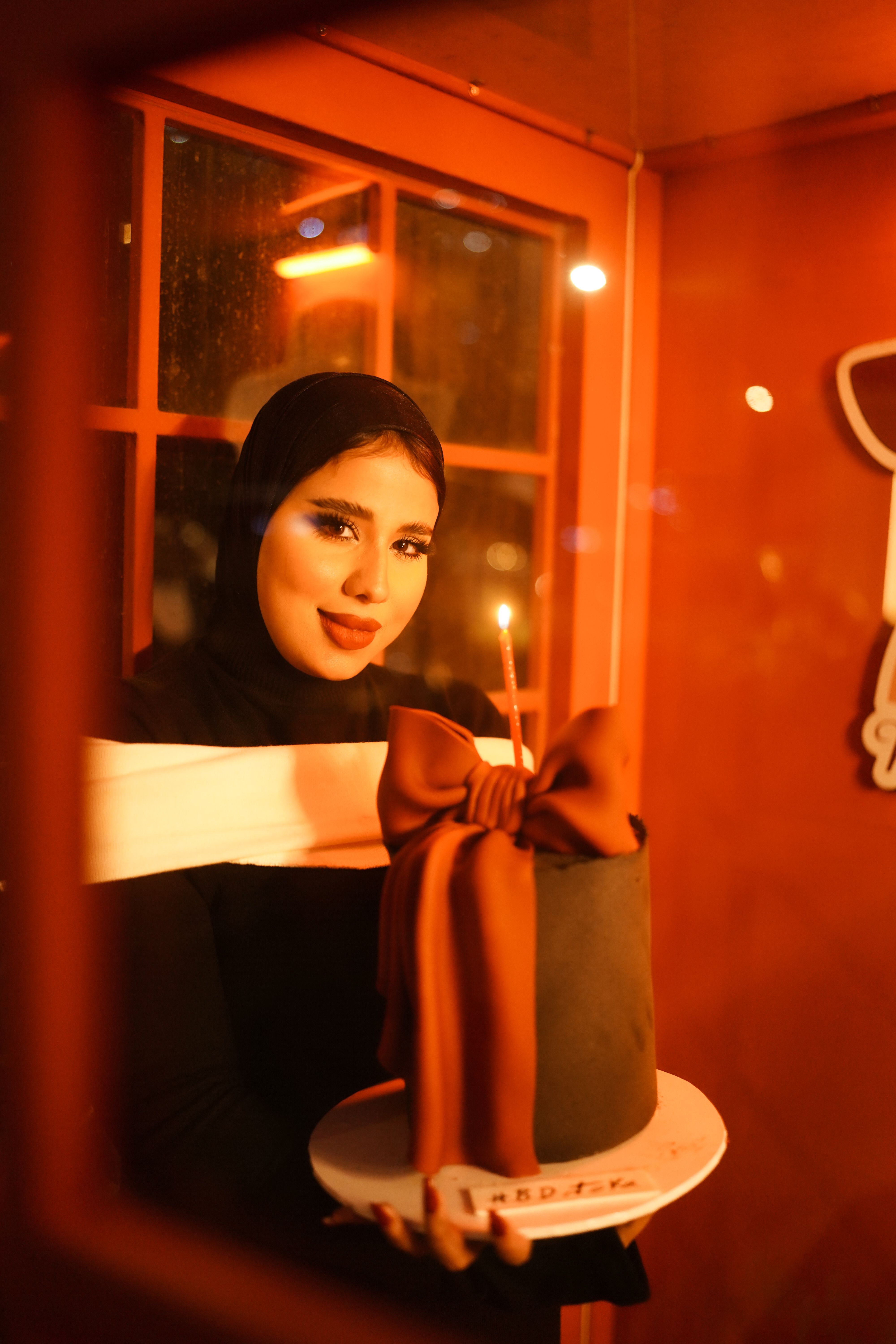 Woman in Hijab Celebrating Birthday with Candlelit Cake · Free Stock Photo