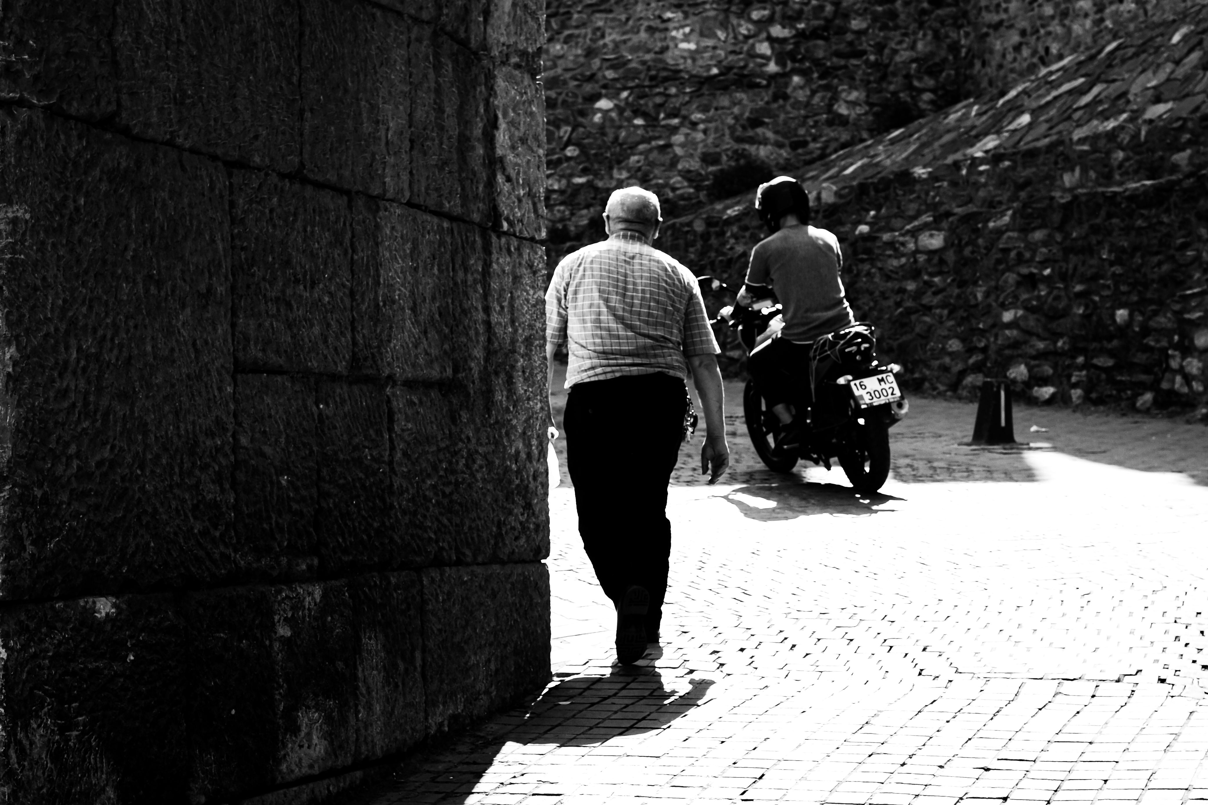 Black and White Street Scene with Walking Man · Free Stock Photo