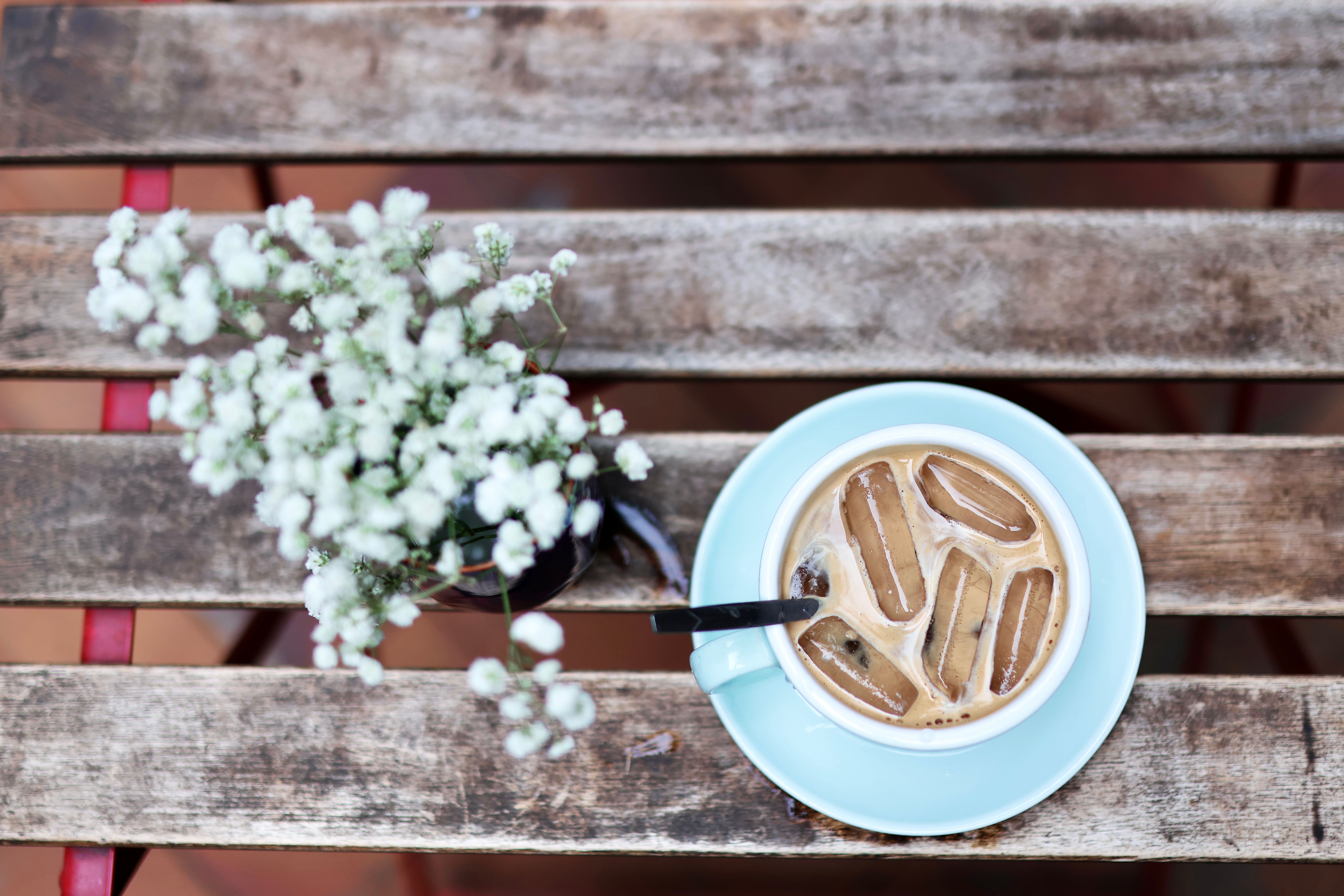 Iced Coffee and Flowers on Rustic Wooden Table · Free Stock Photo