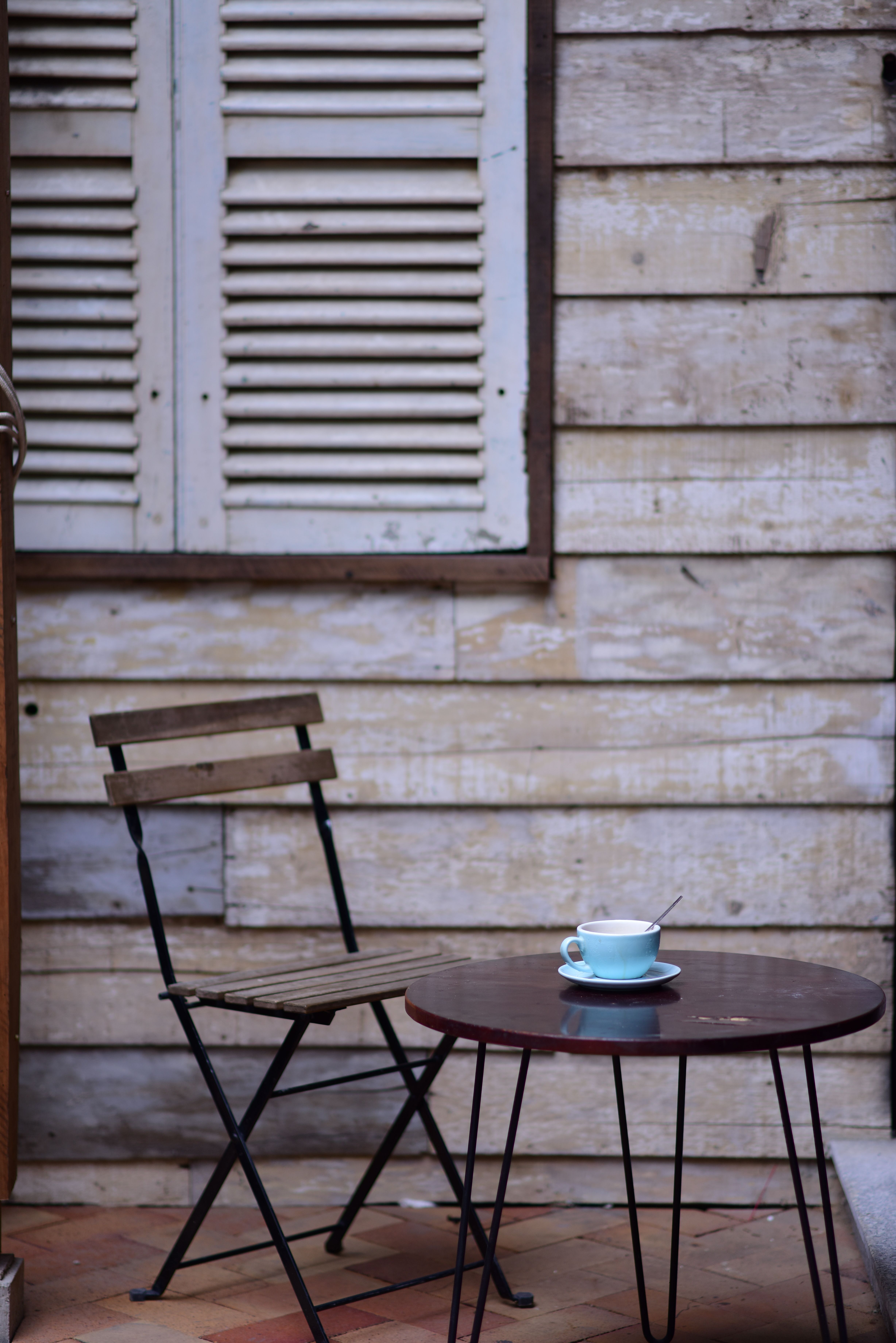Rustic Outdoor Café Scene with Coffee Cup · Free Stock Photo