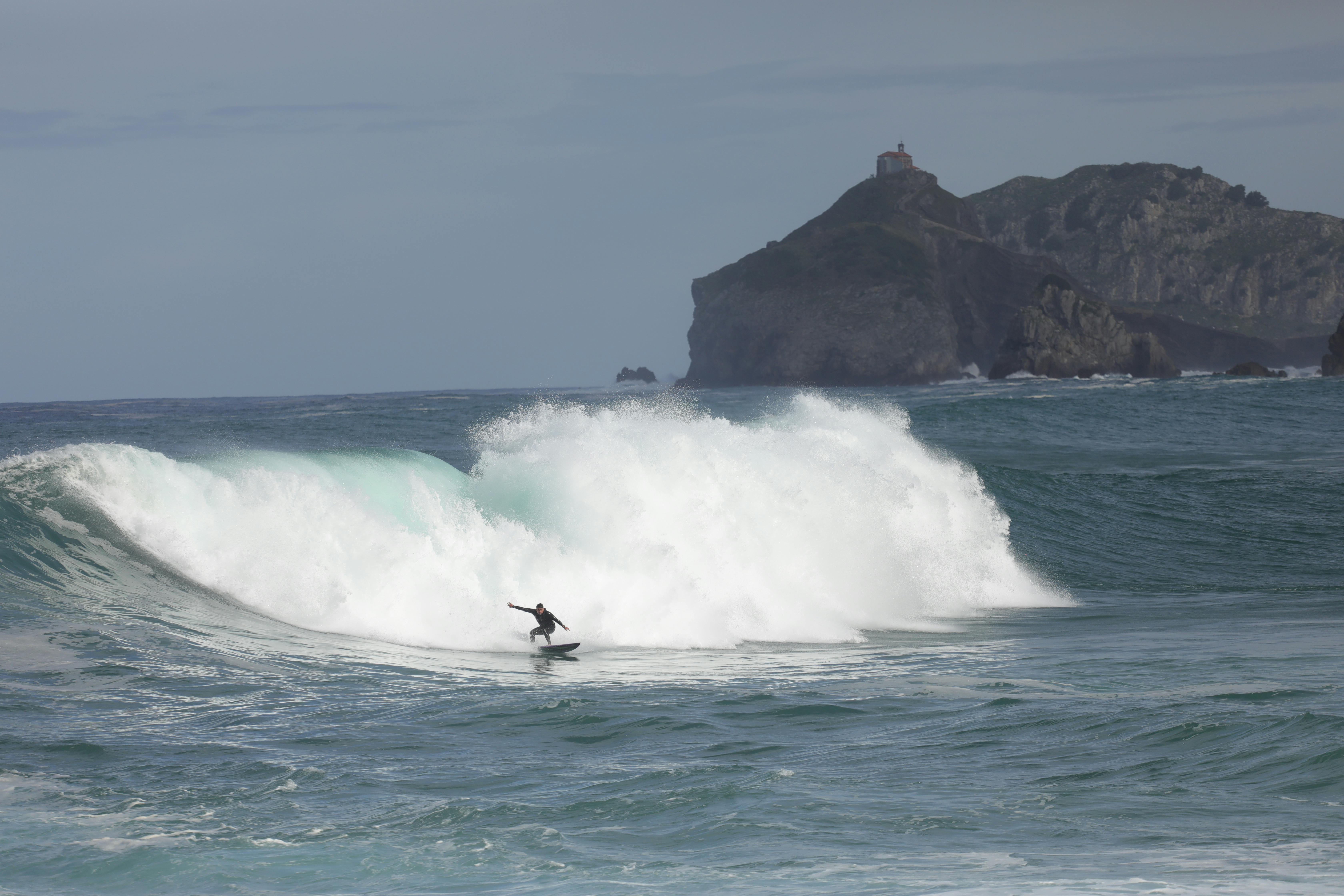 Surfing Adventure at Gaztelugatxe in Basque Country · Free Stock Photo