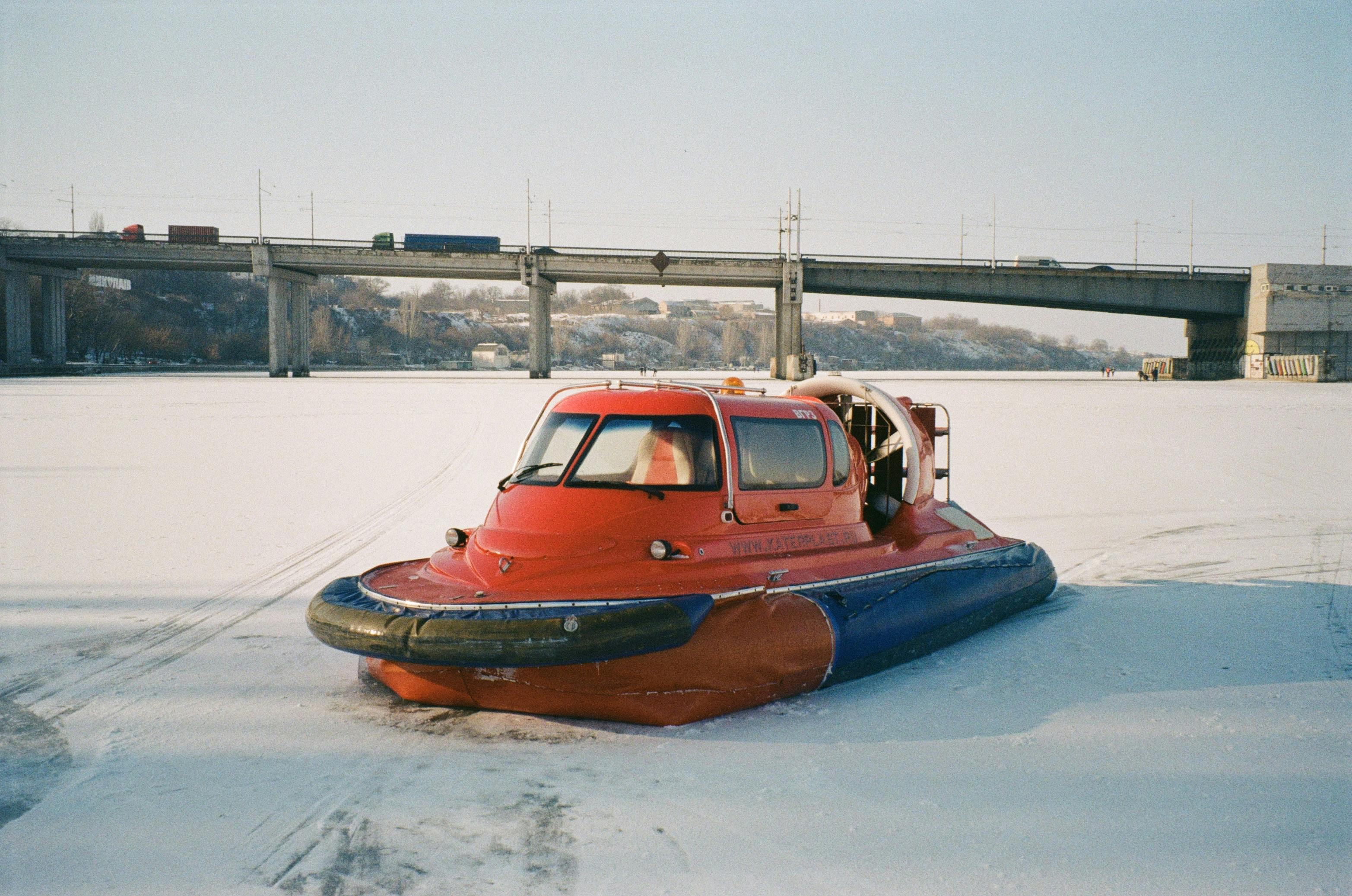 Colorful hovercraft on a frozen river · Free Stock Photo