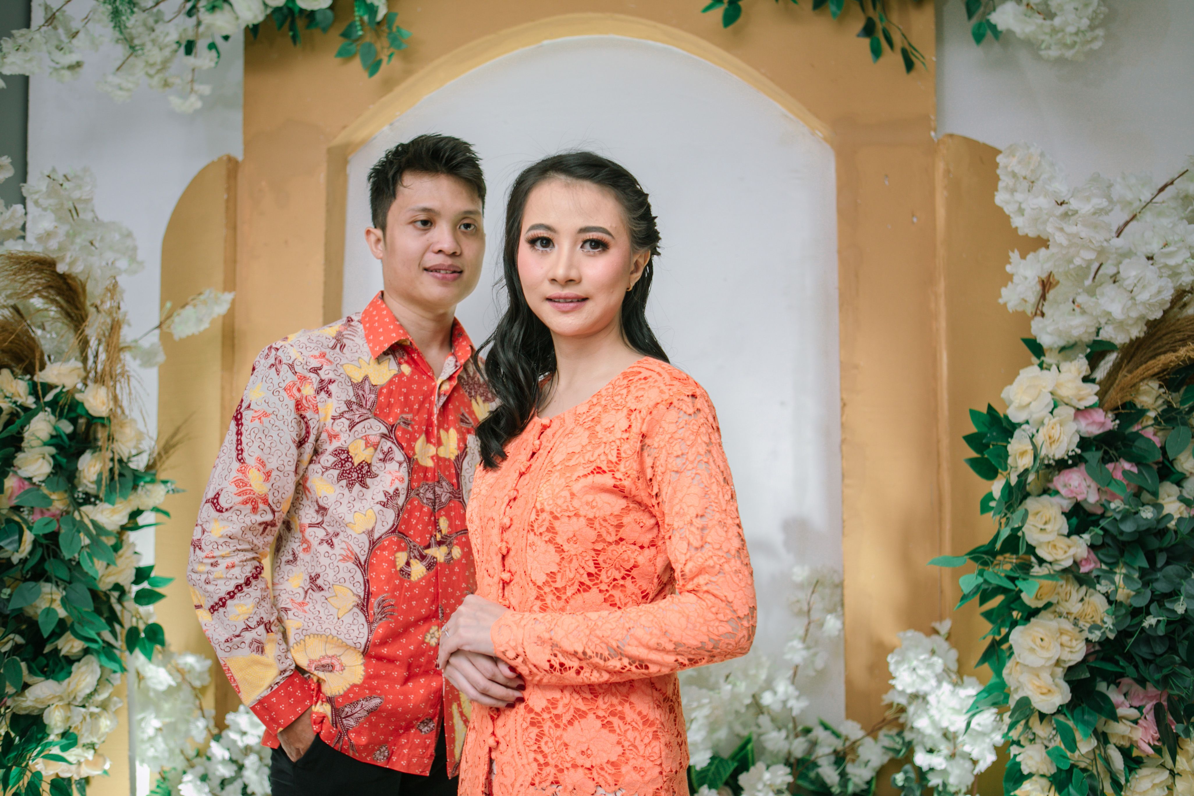 Couple Posing in Traditional Batik Attire · Free Stock Photo