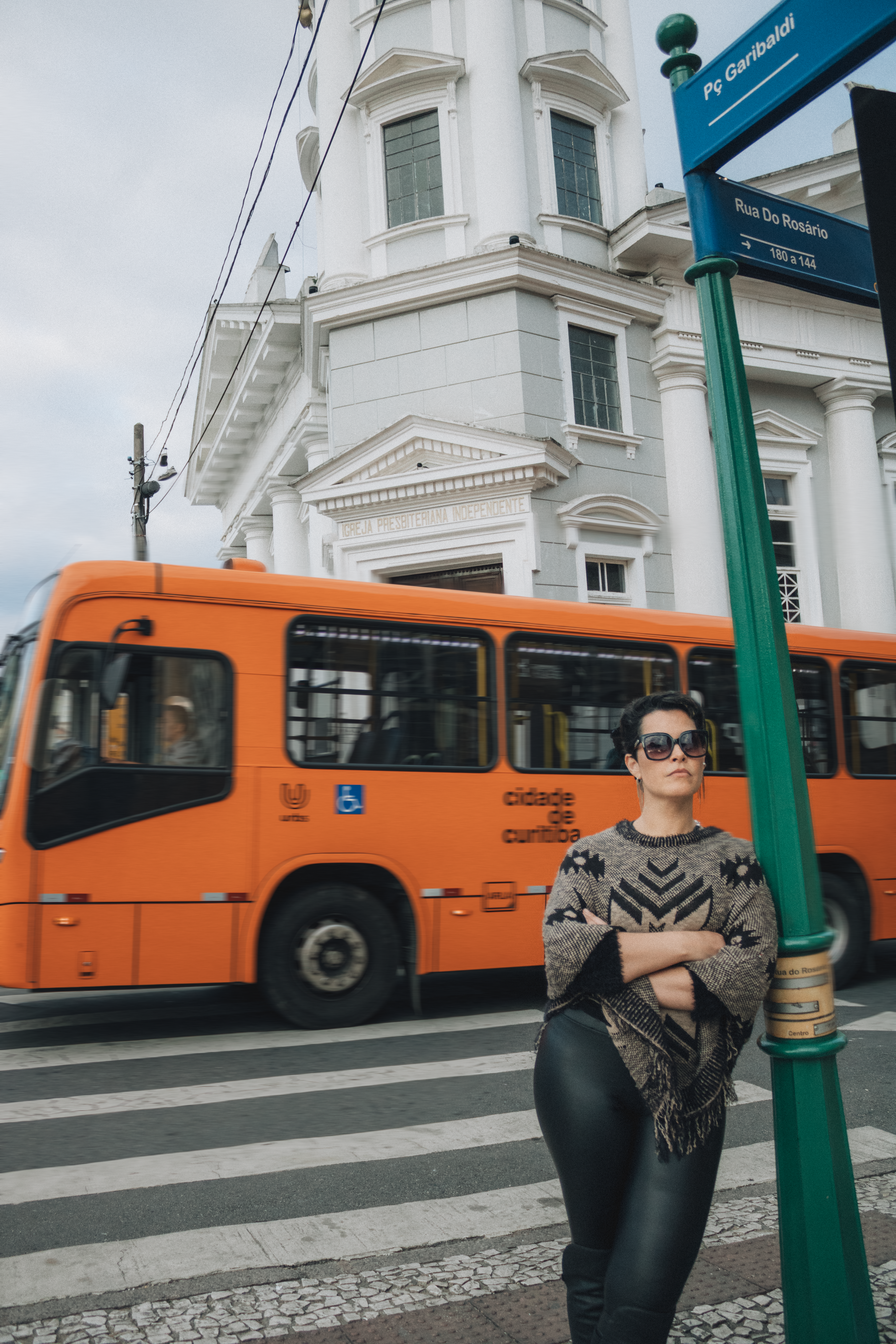 Person Waiting at Bus Stop in Urban Street Scene · Free Stock Photo