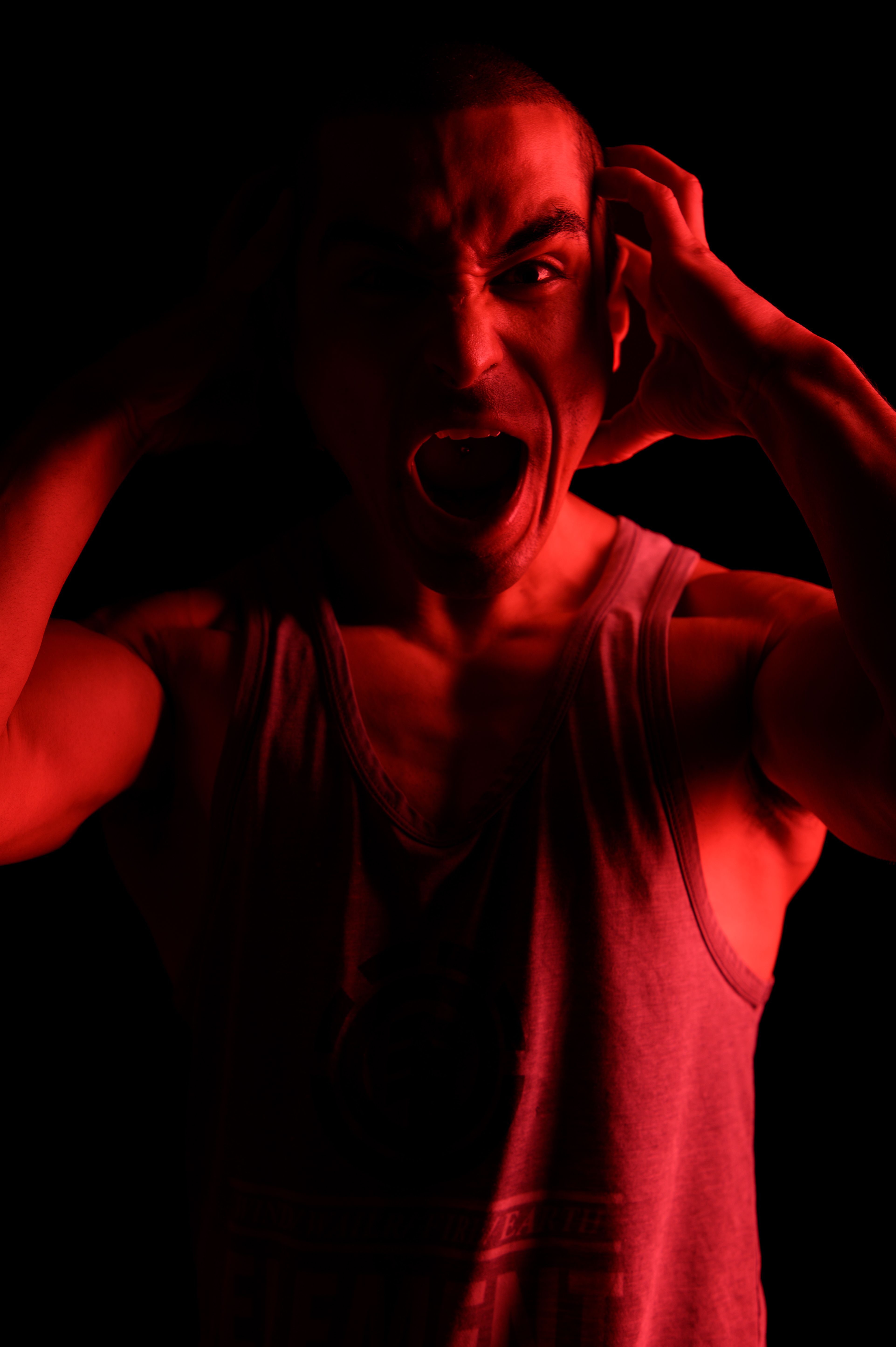 Dramatic Red Lit Portrait of a Man Expressing Emotion · Free Stock Photo