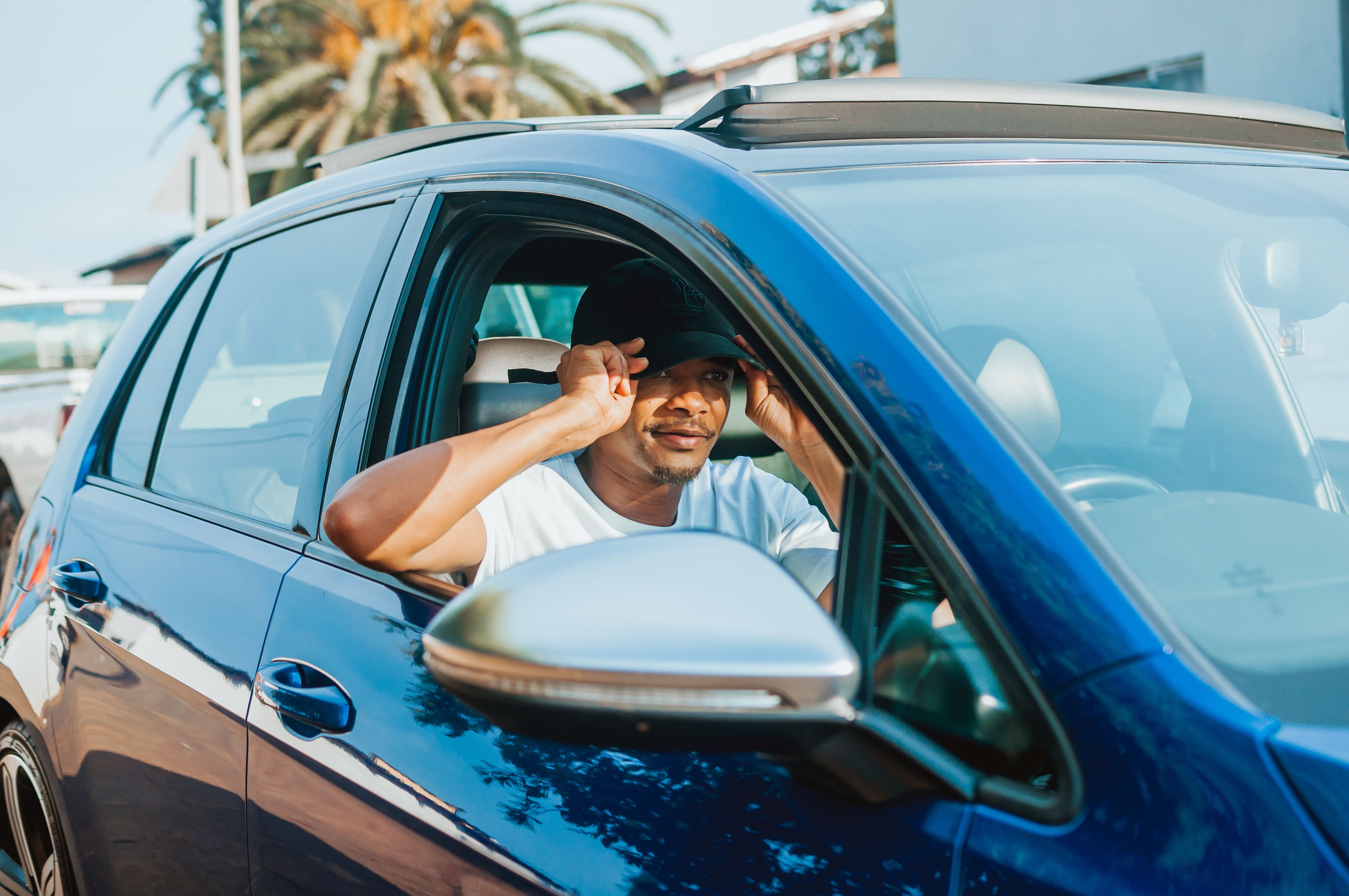 Man Driving Blue Car on Sunny Day · Free Stock Photo