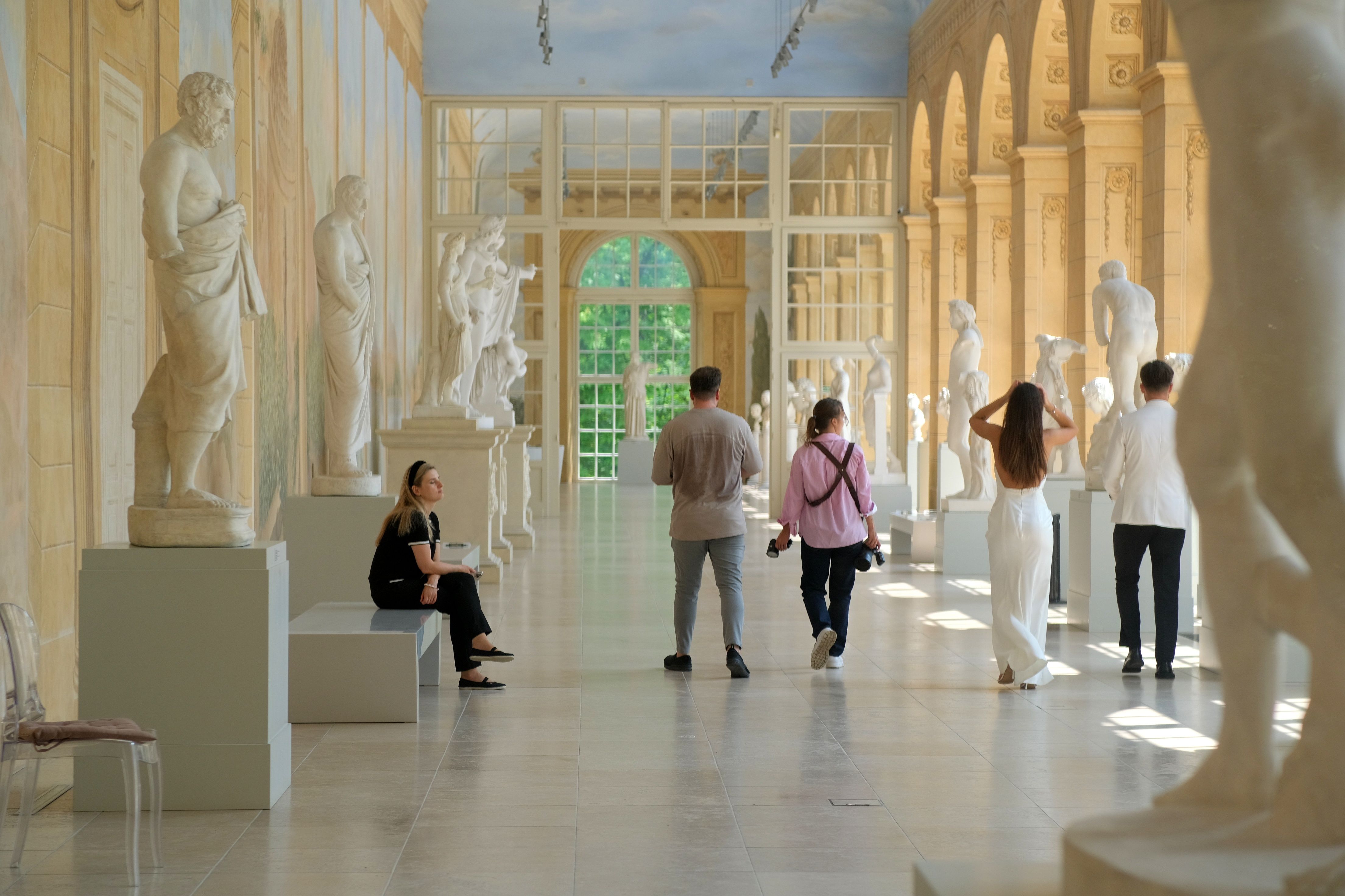 Man Admiring Classical Sculptures in Museum · Free Stock Photo