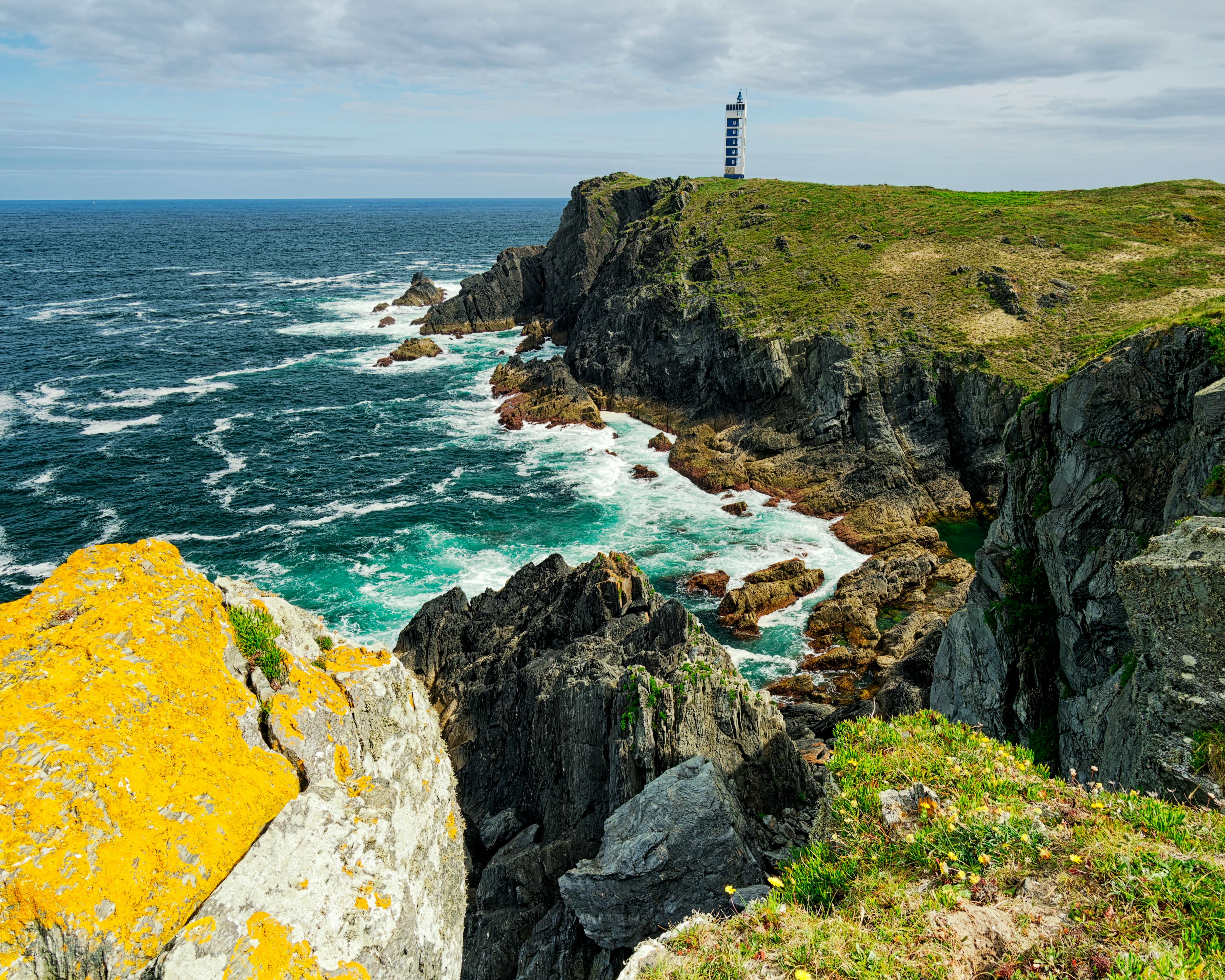 Dramatic Coastal View with Remote Lighthouse · Free Stock Photo
