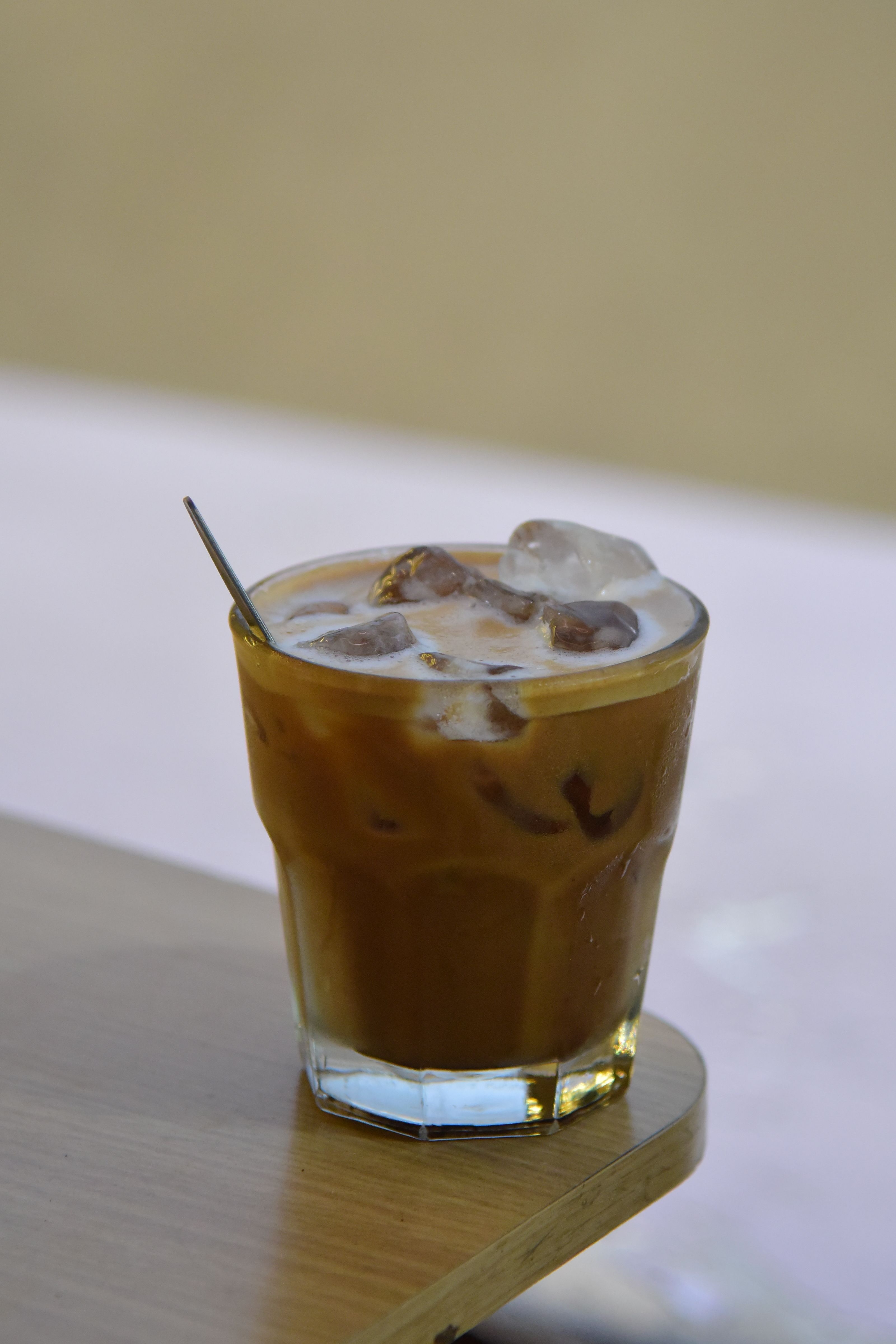 Refreshing Iced Coffee with Cream on Wooden Table · Free Stock Photo