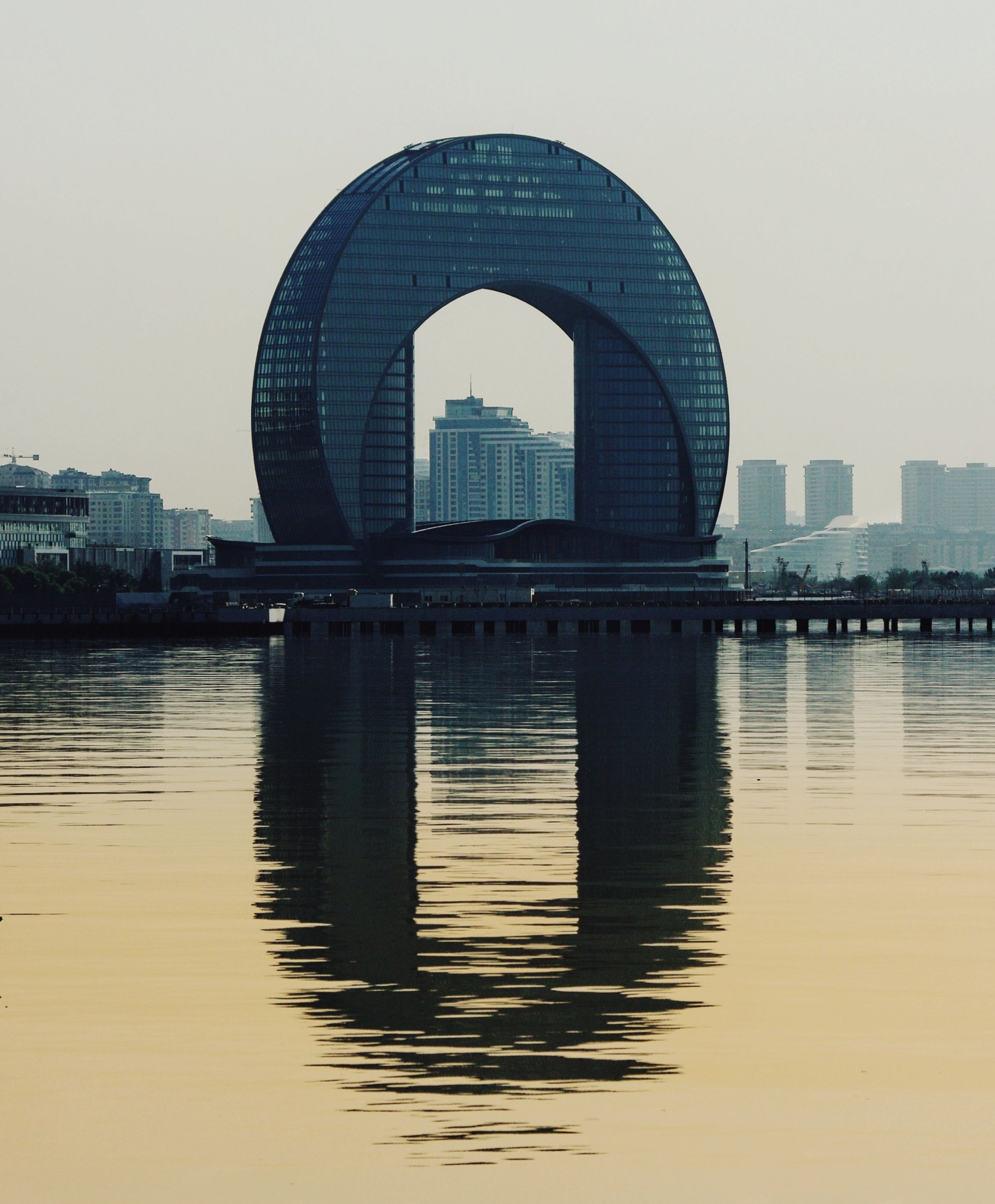 Modern Architectural Landmark Over Water Reflection · Free Stock Photo