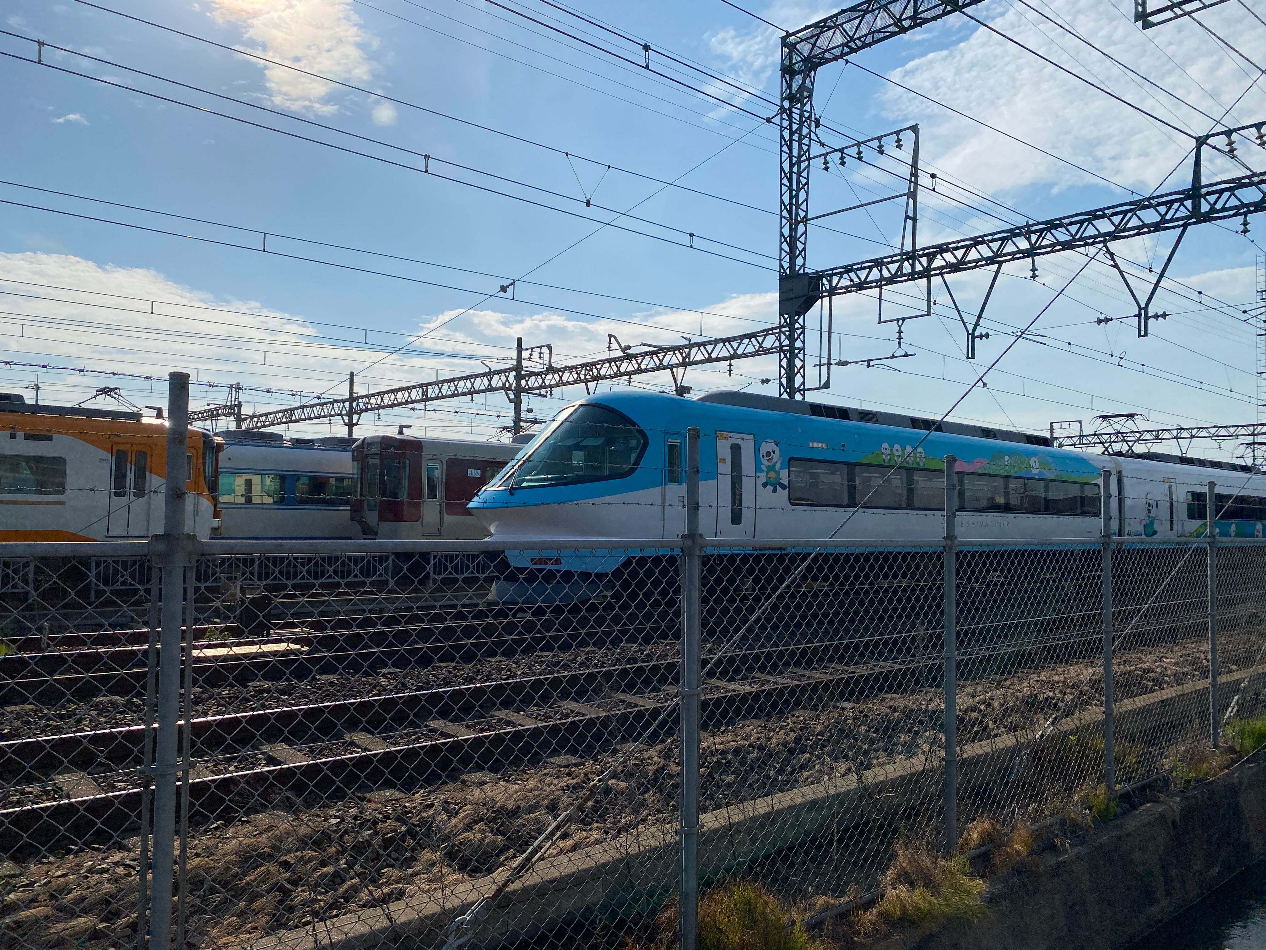 Modern Blue Train Passing Through Rail Yard · Free Stock Photo