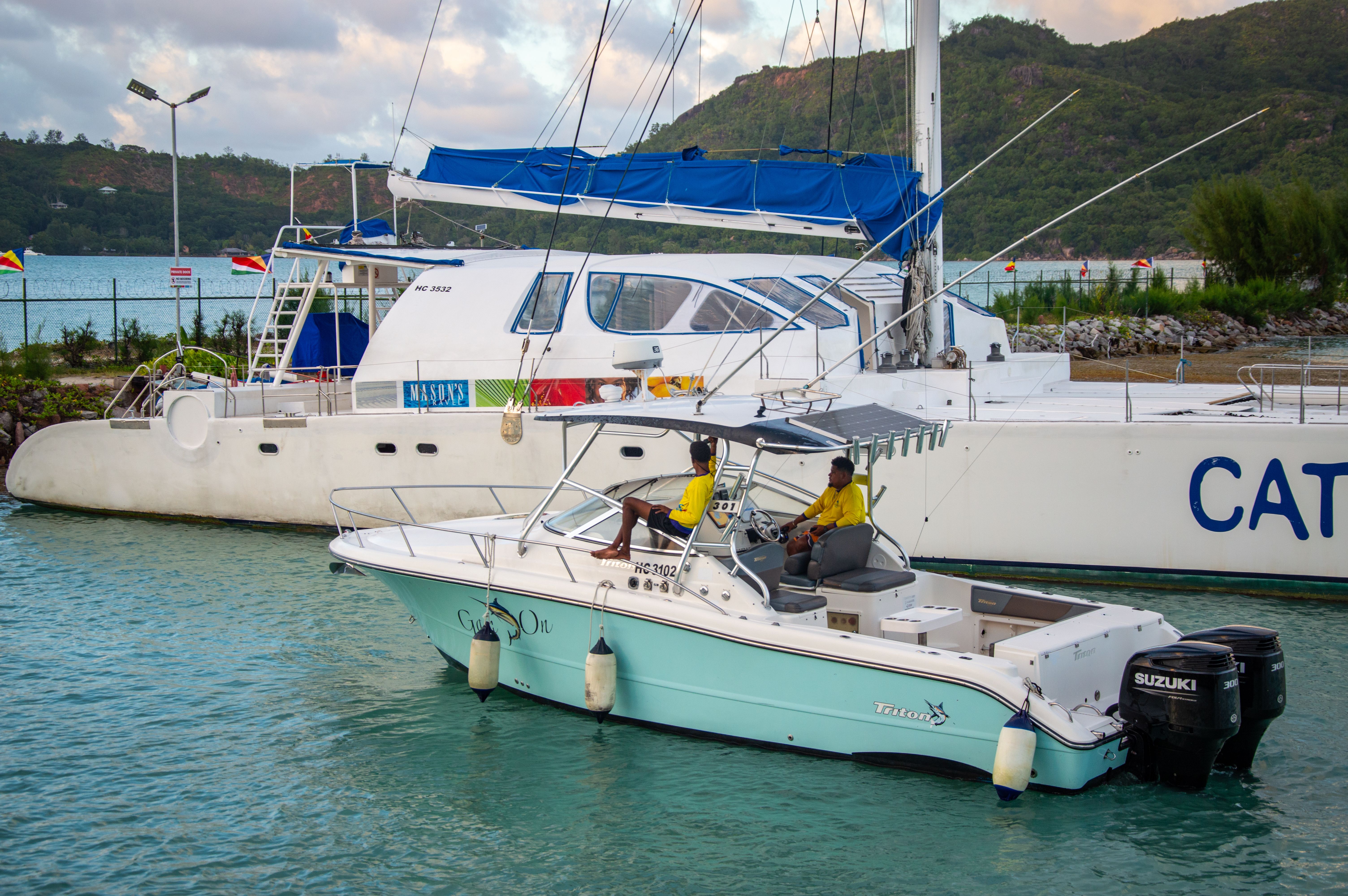Catamaran and Motorboat in Tropical Marina · Free Stock Photo