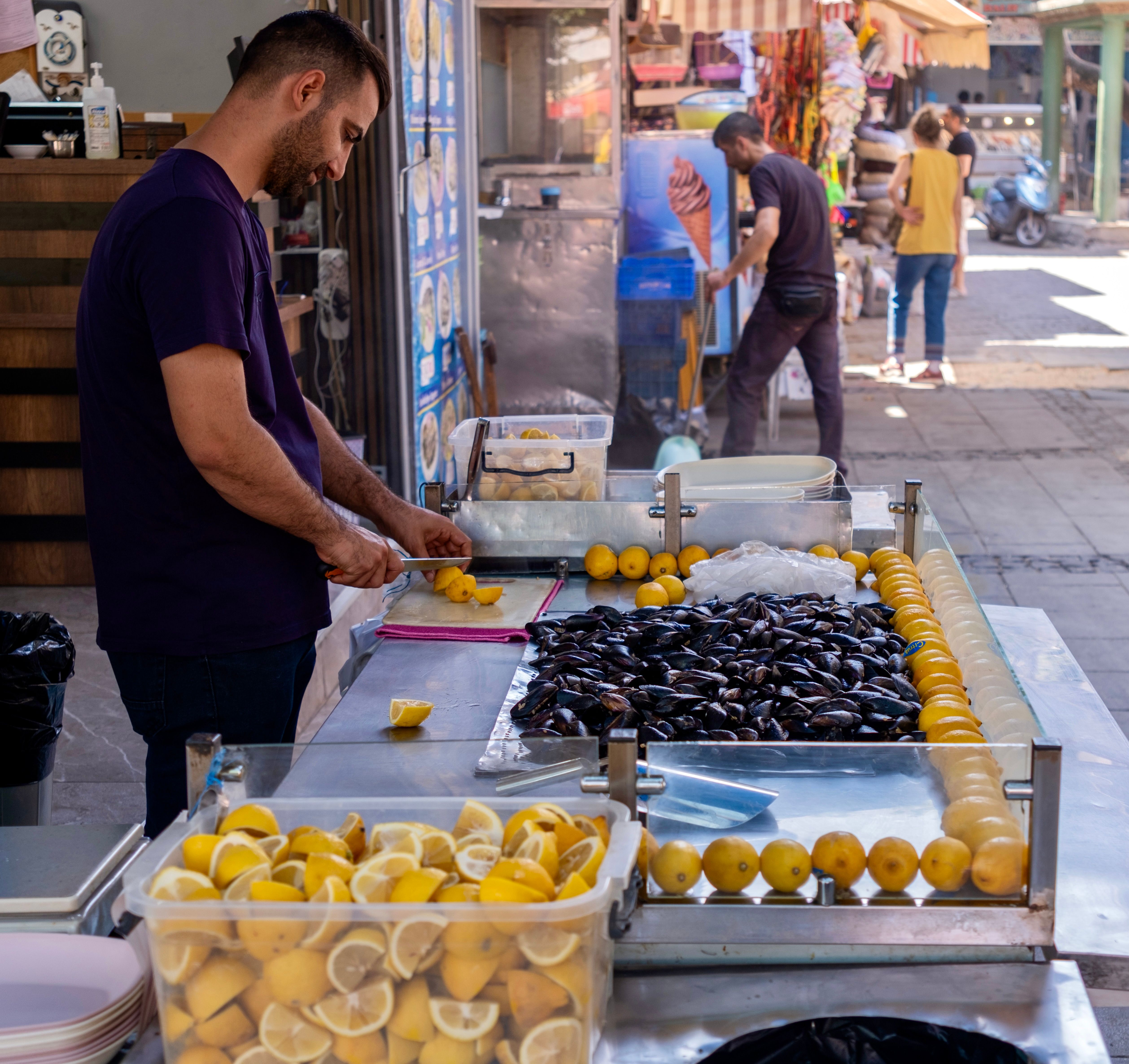 Street Vendor Preparing Fresh Lemons and Mussels in İzmir · Free Stock ...
