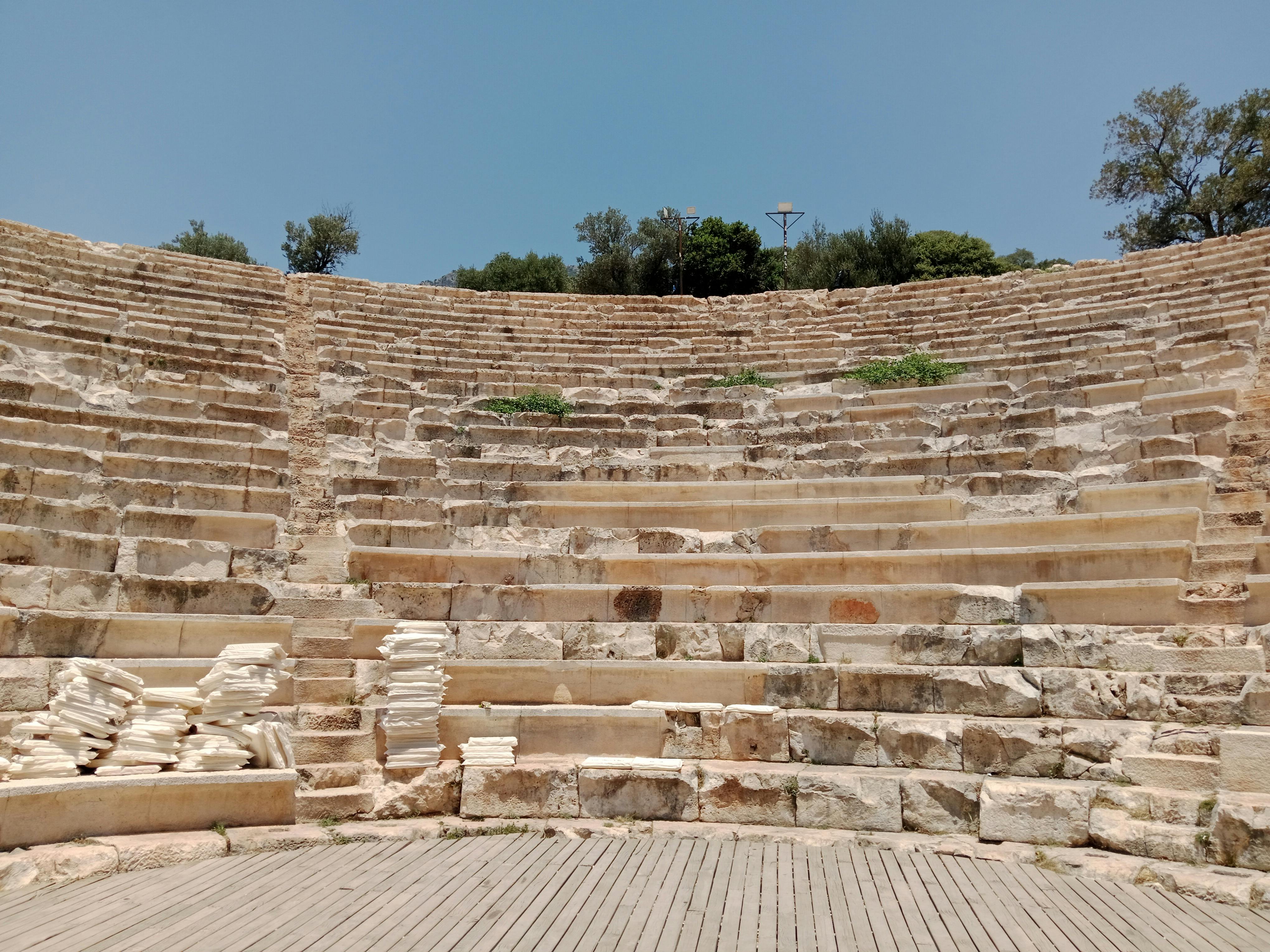 Ancient Stone Amphitheater Under Clear Sky · Free Stock Photo