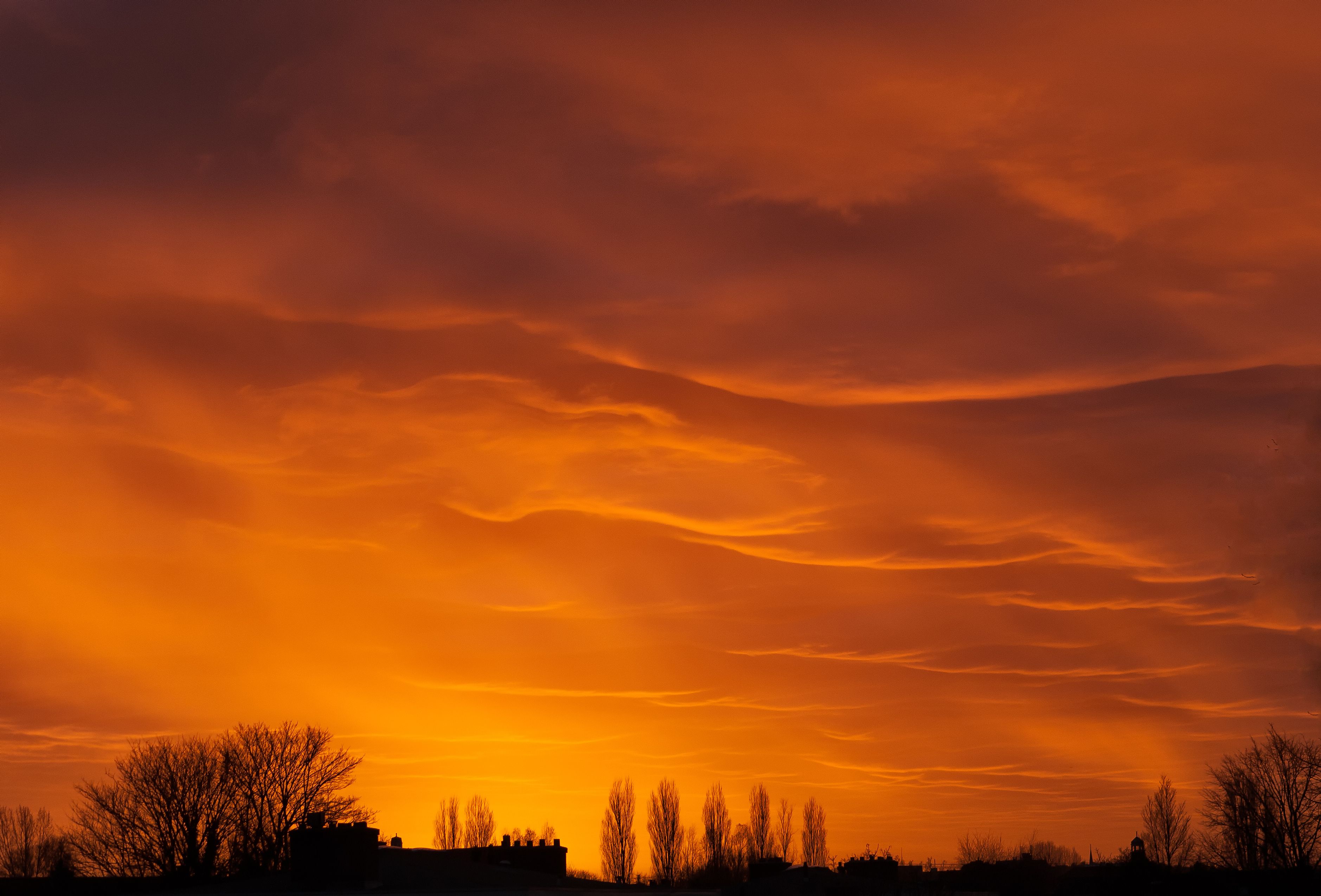 Captivating Sunset with Illuminated Cloud Formations · Free Stock Photo