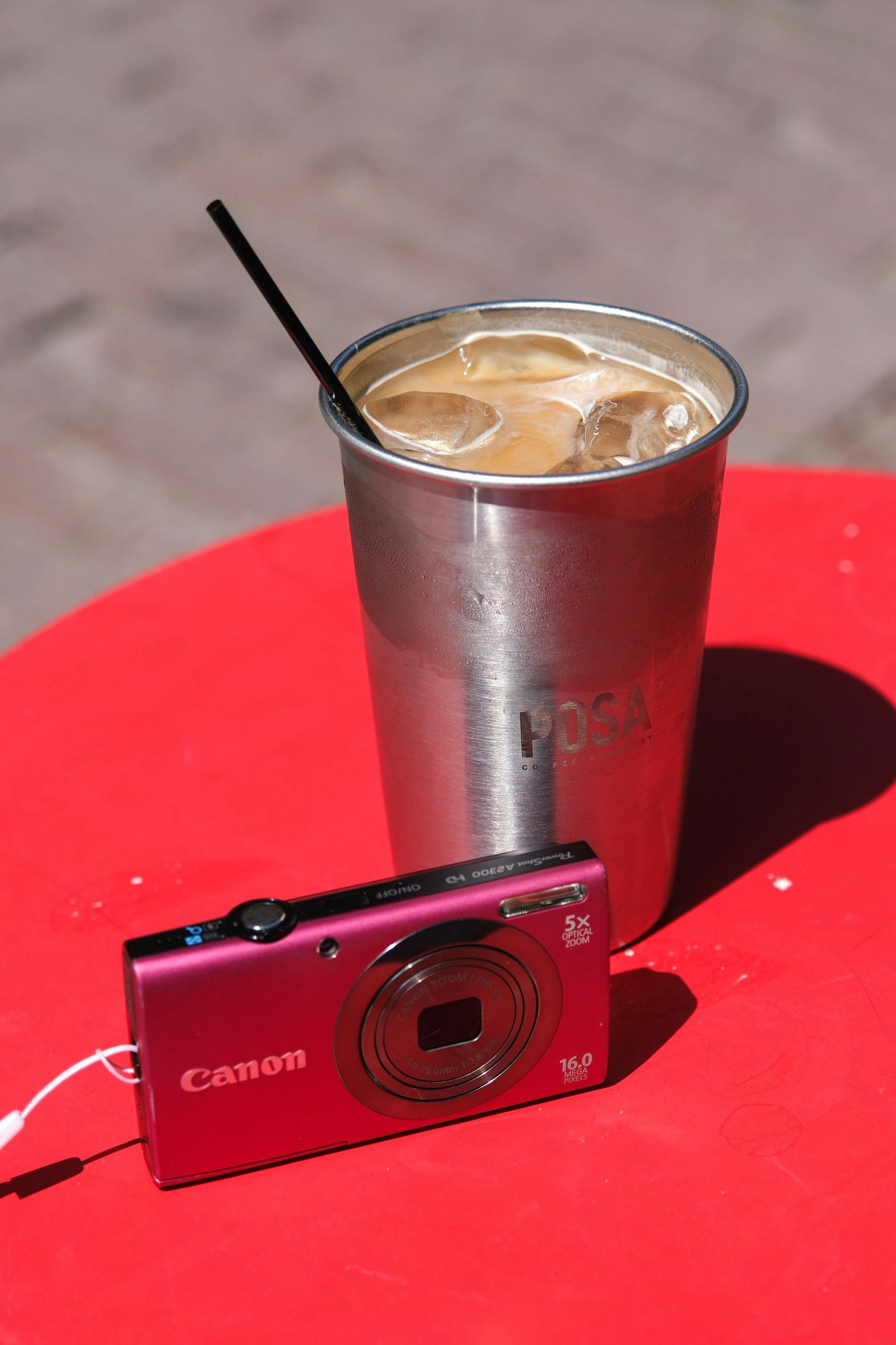 Iced Coffee and Camera on Red Table Outdoors · Free Stock Photo