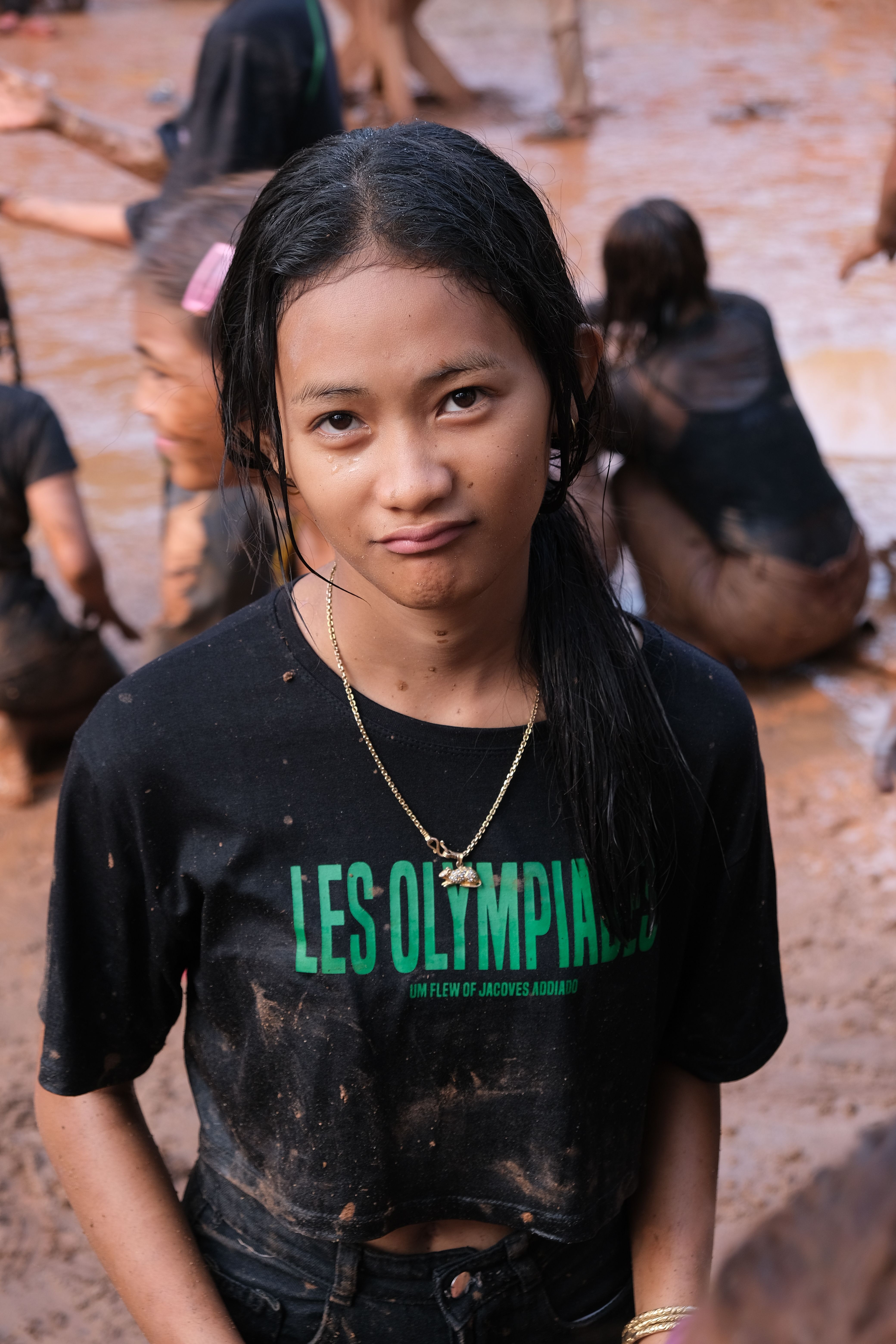 Young girl enjoying mud festival in Cambodia · Free Stock Photo