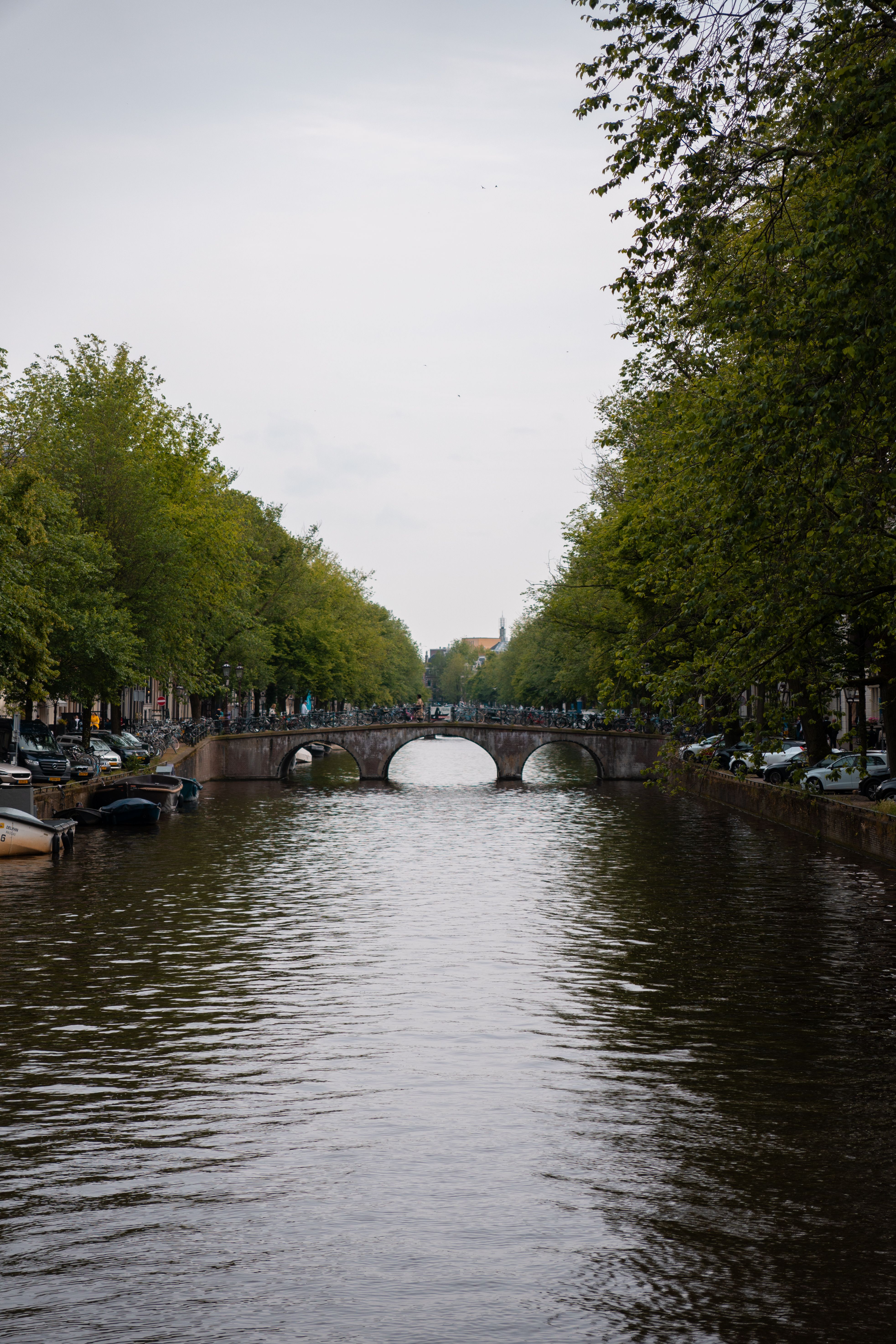 Scenic Amsterdam Canal with Historic Bridge · Free Stock Photo