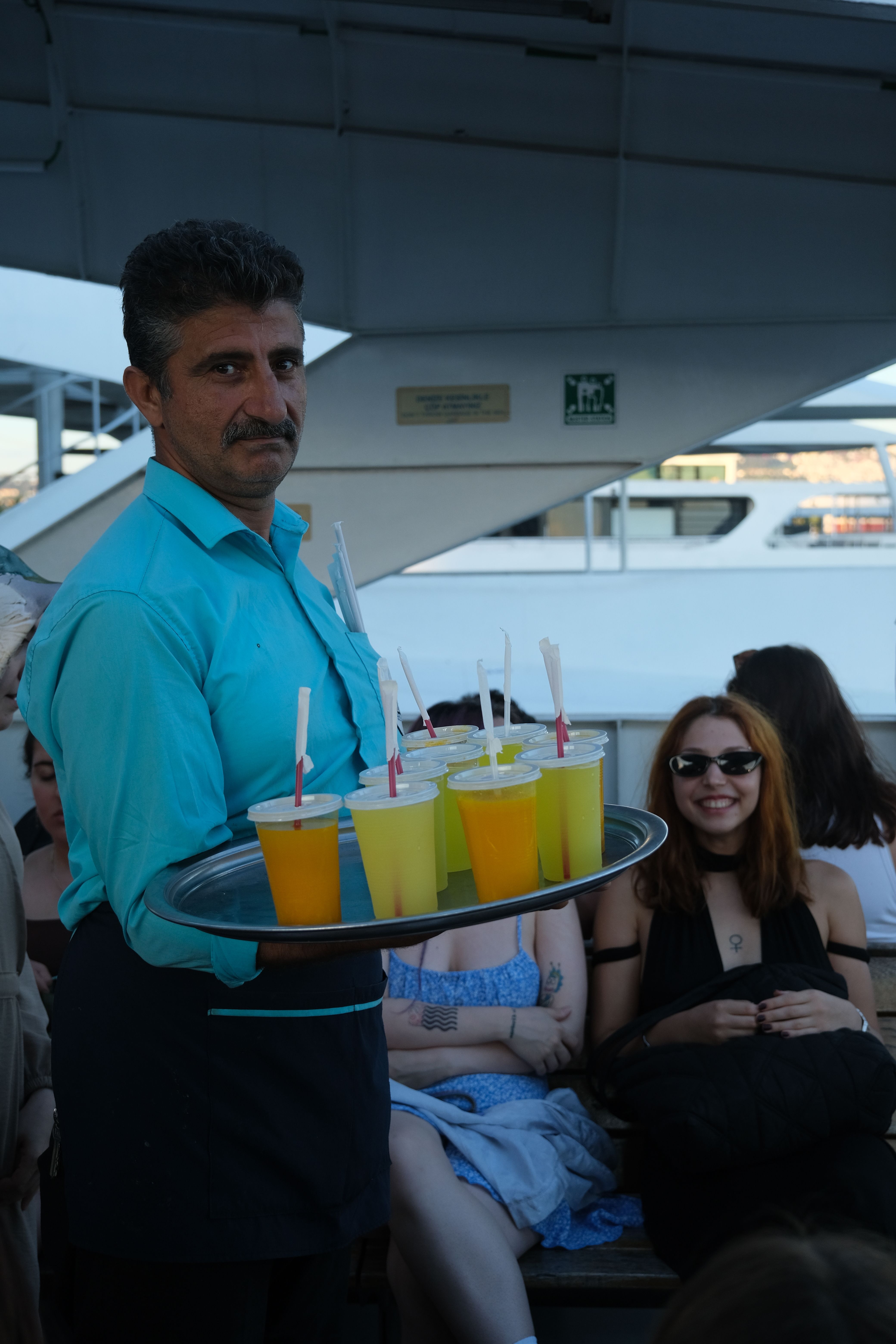Waiter Serving Drinks on a Boat in Istanbul · Free Stock Photo
