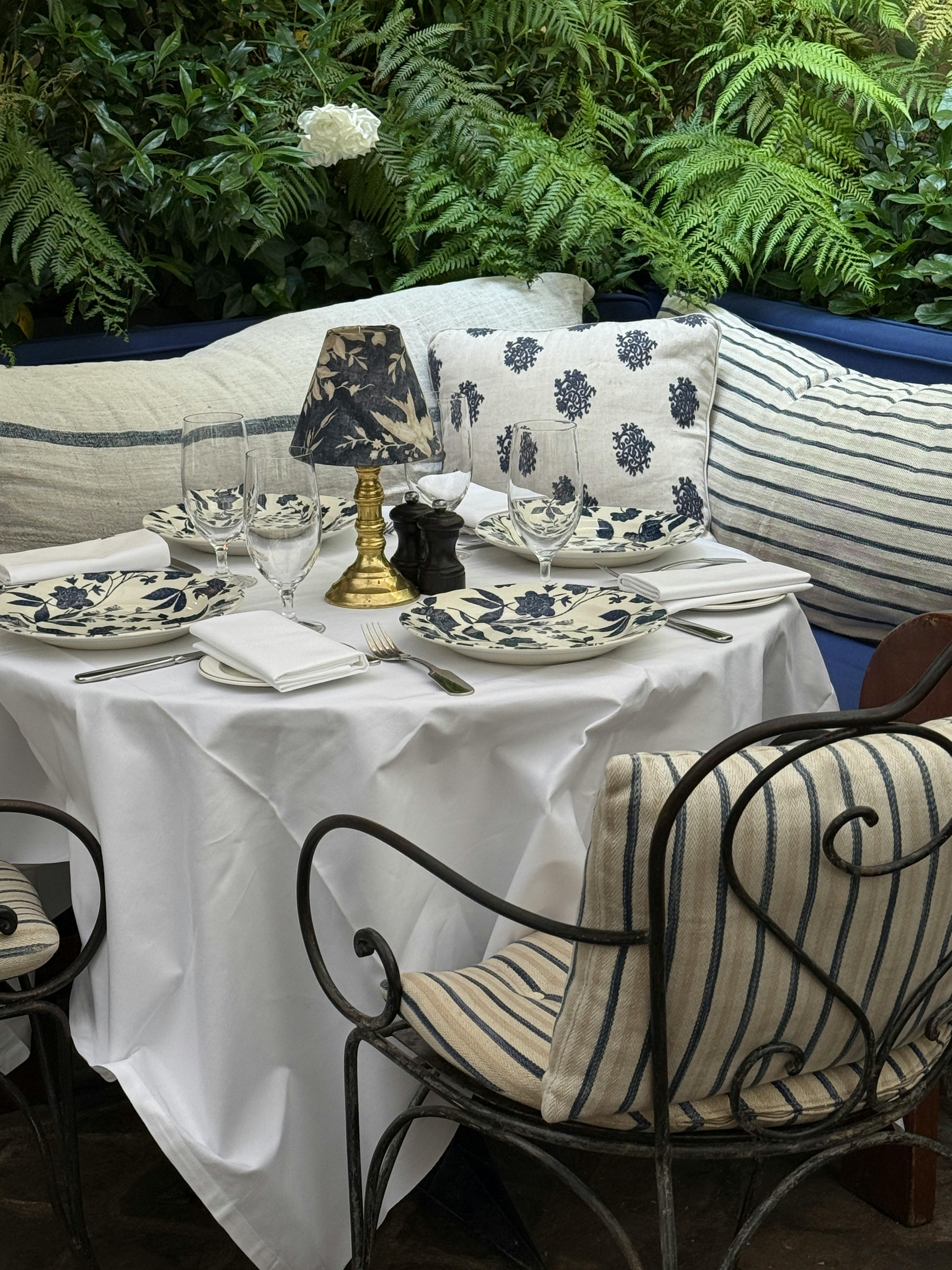 Elegant Outdoor Cafe Table Setting with Ferns · Free Stock Photo