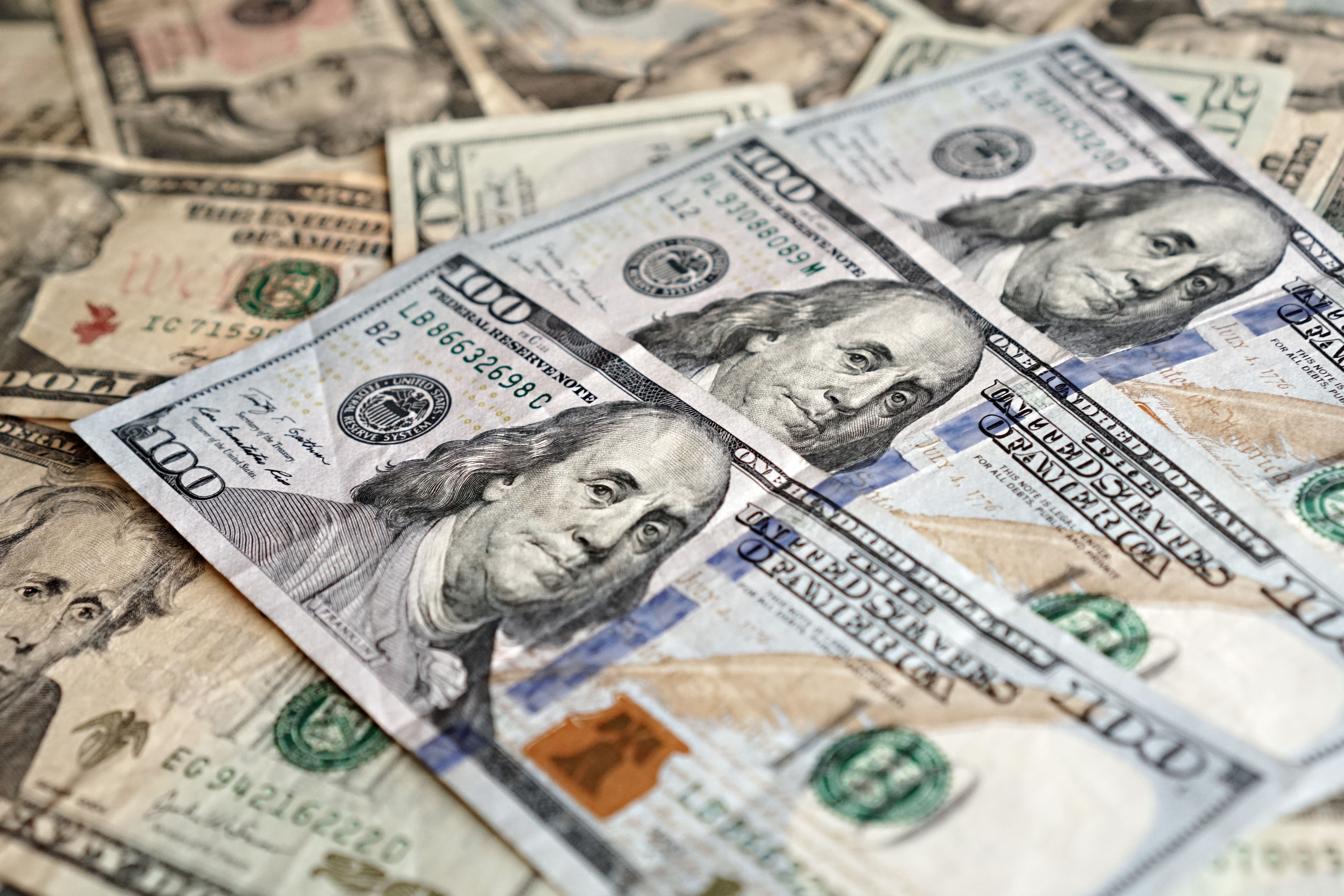Close-up of US Dollar Bills in a Pile · Free Stock Photo