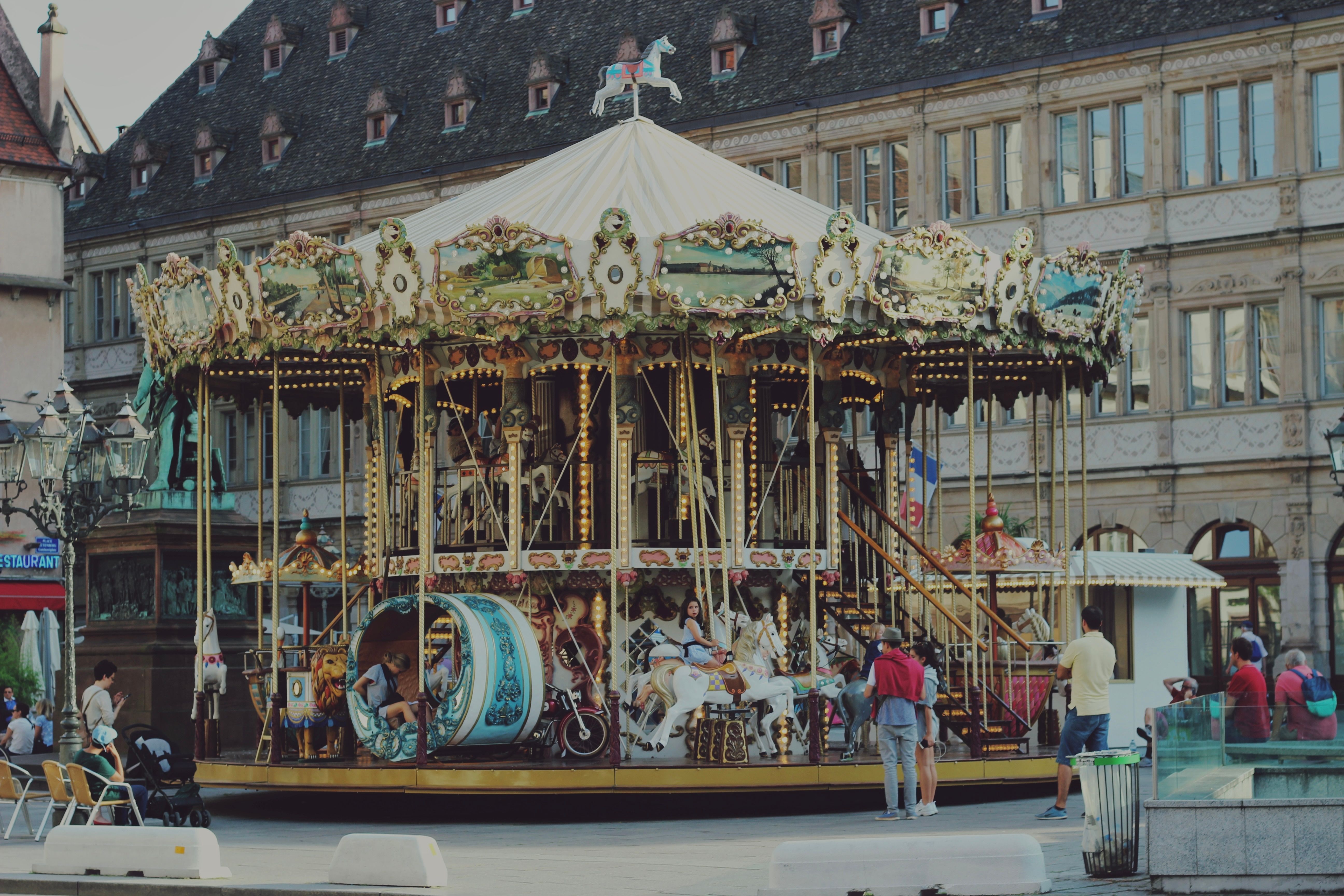 Charming Vintage Carousel in Historical Town Square · Free Stock Photo