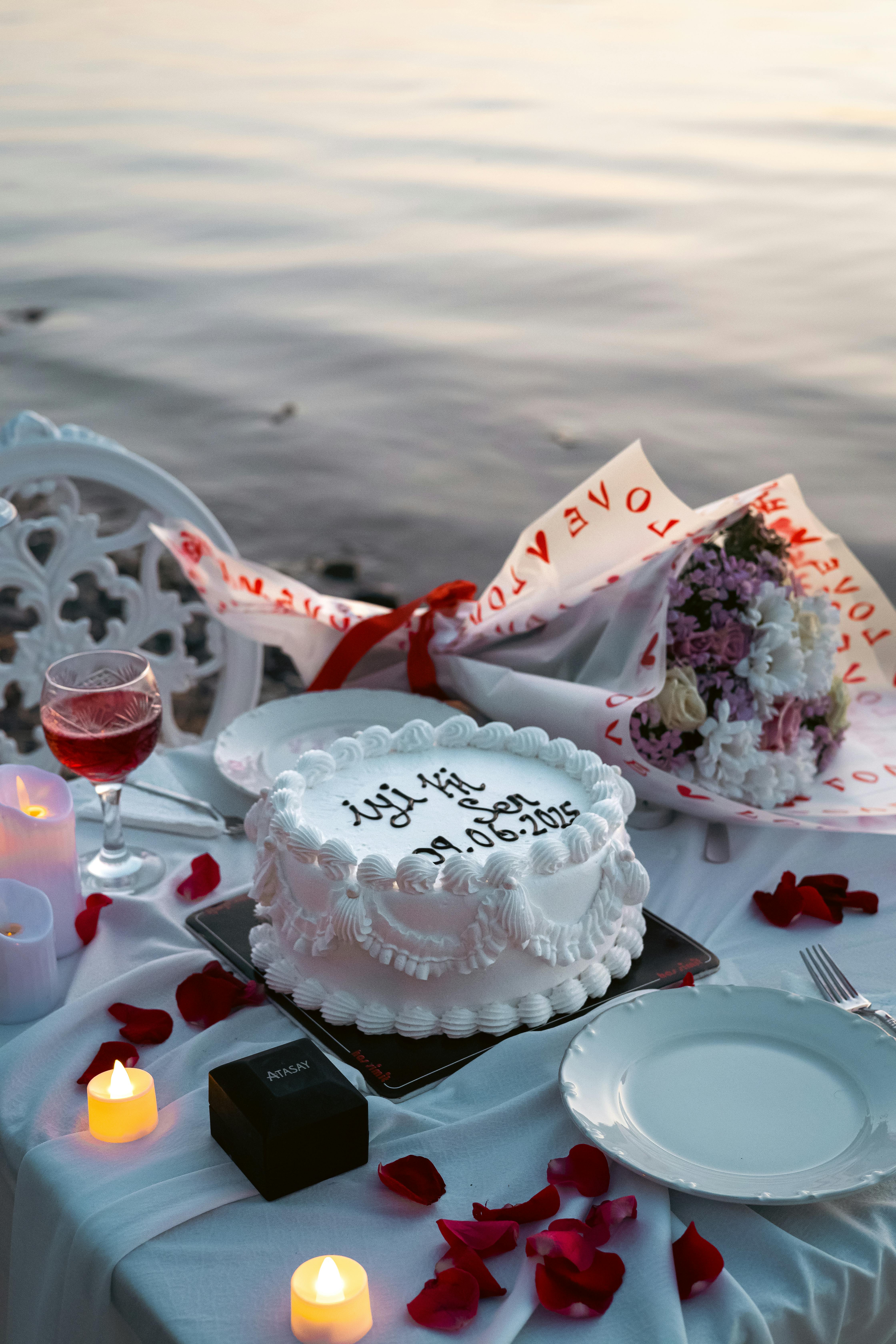 Romantic Waterfront Cake Setup at Sunset · Free Stock Photo